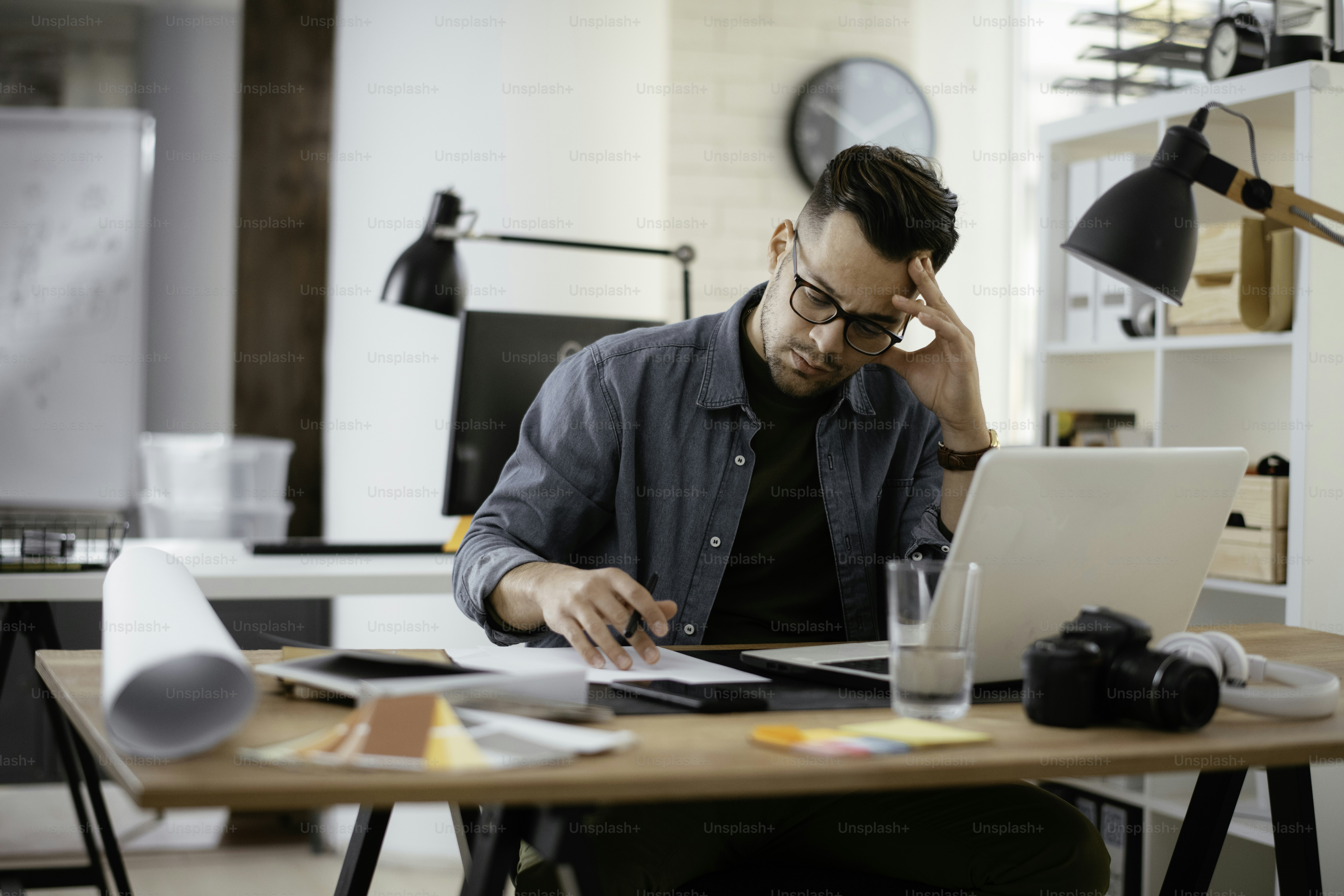 Young businessman working in the office. Handsome man working on laptop ...