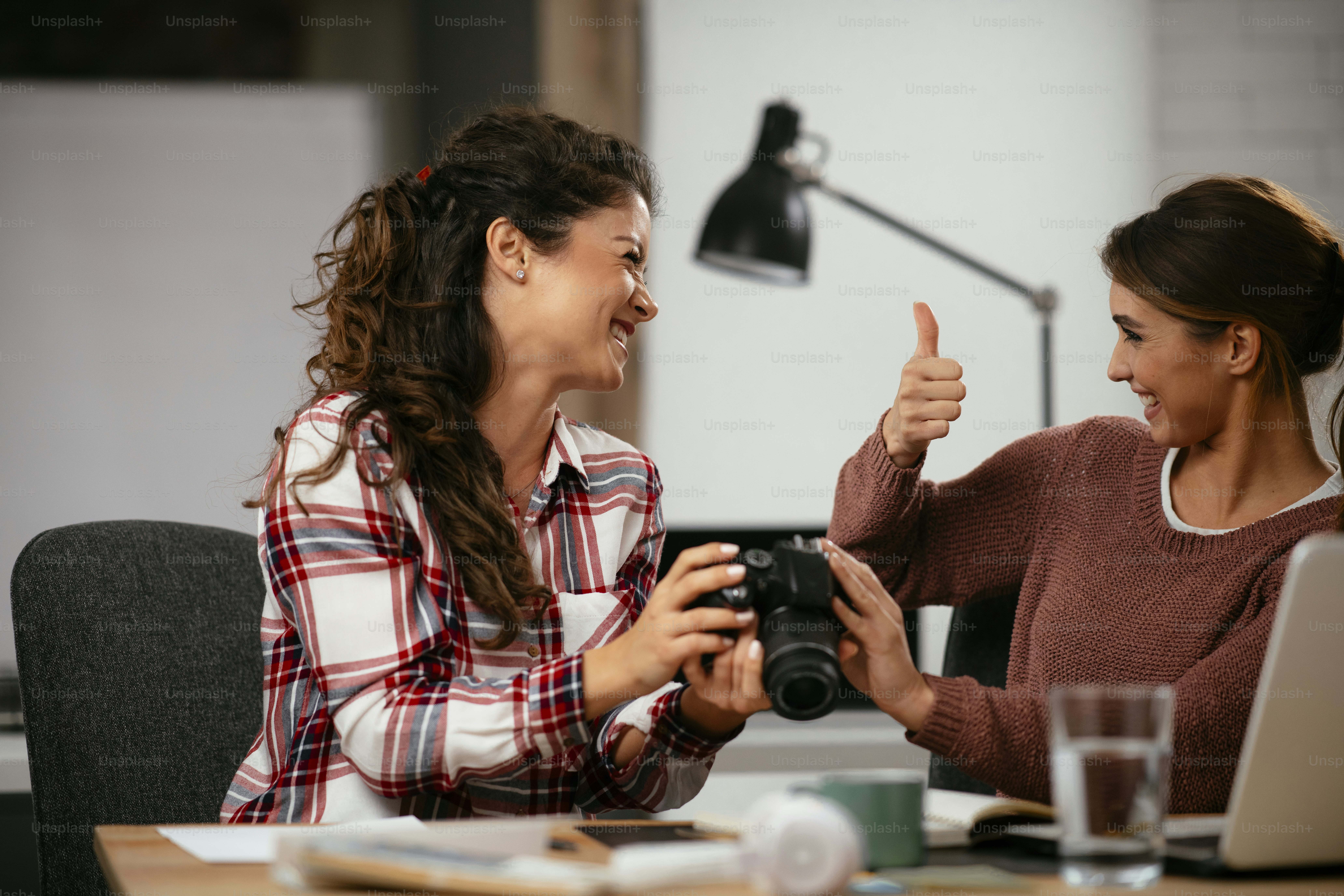 Girlfriends working together in the office. Female friends having fun ...