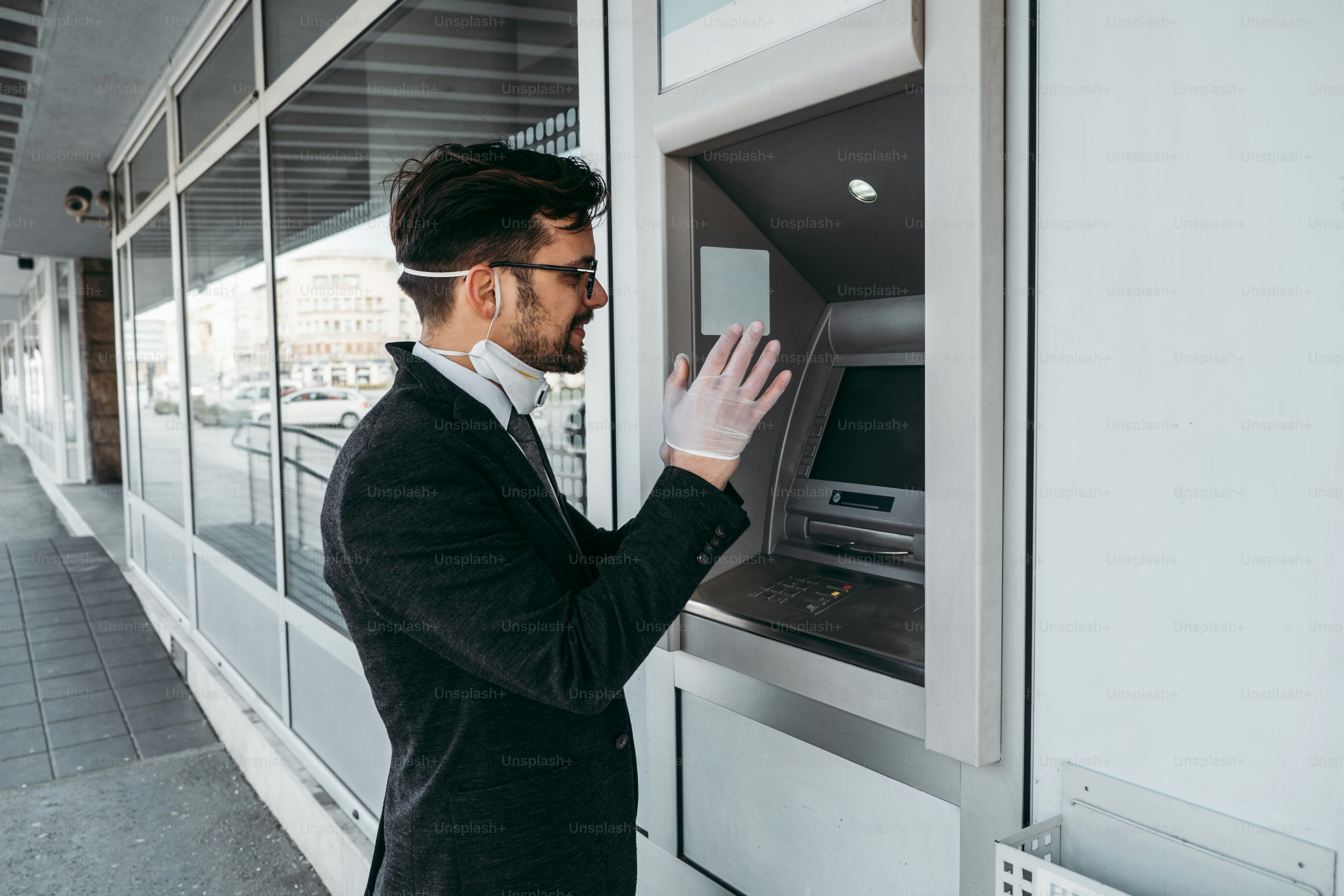 Business man with protective face mask and gloves using street ATM ...
