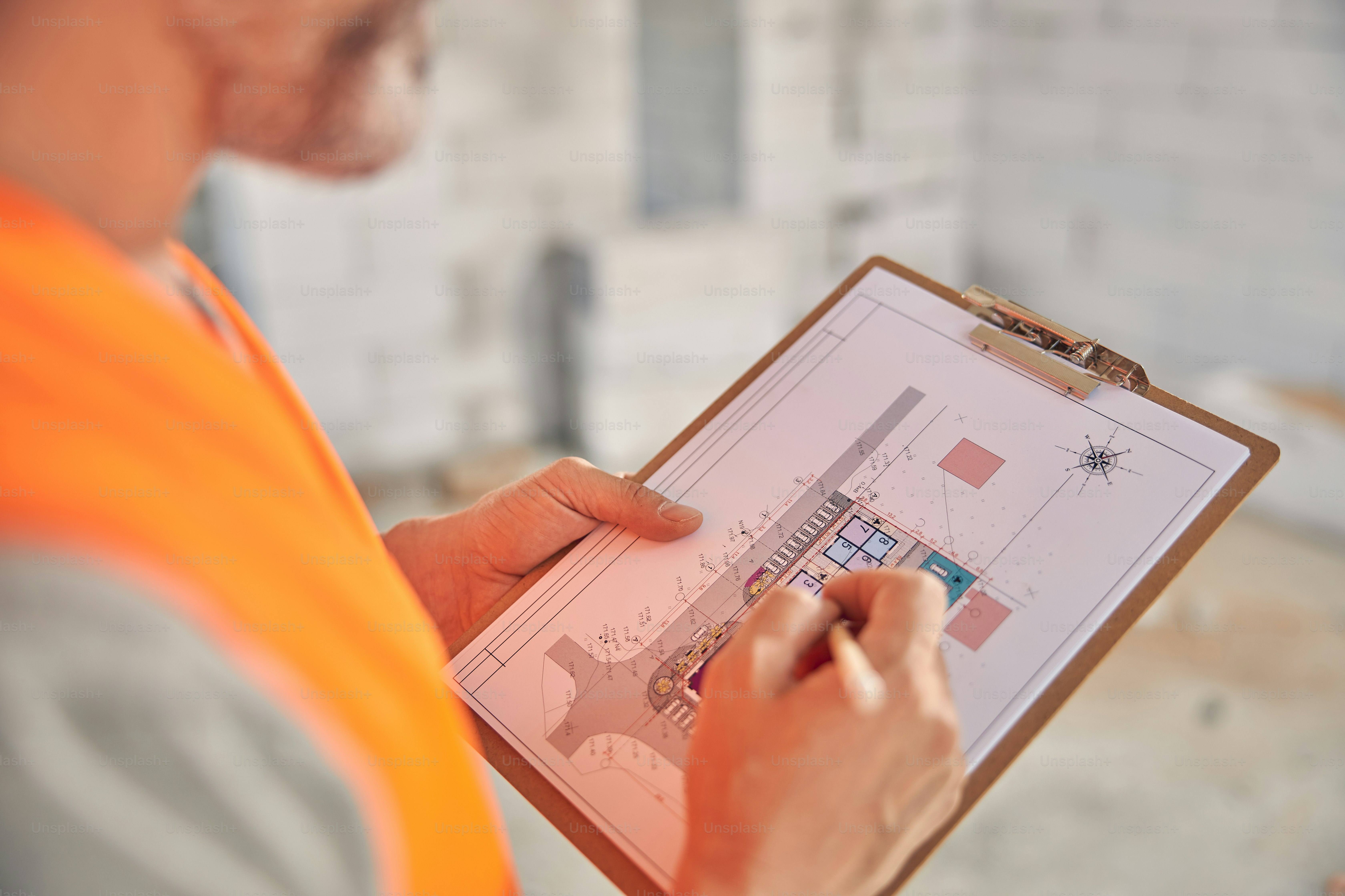 Cropped photo of a qualifed Caucasian civil engineer drawing with a ...