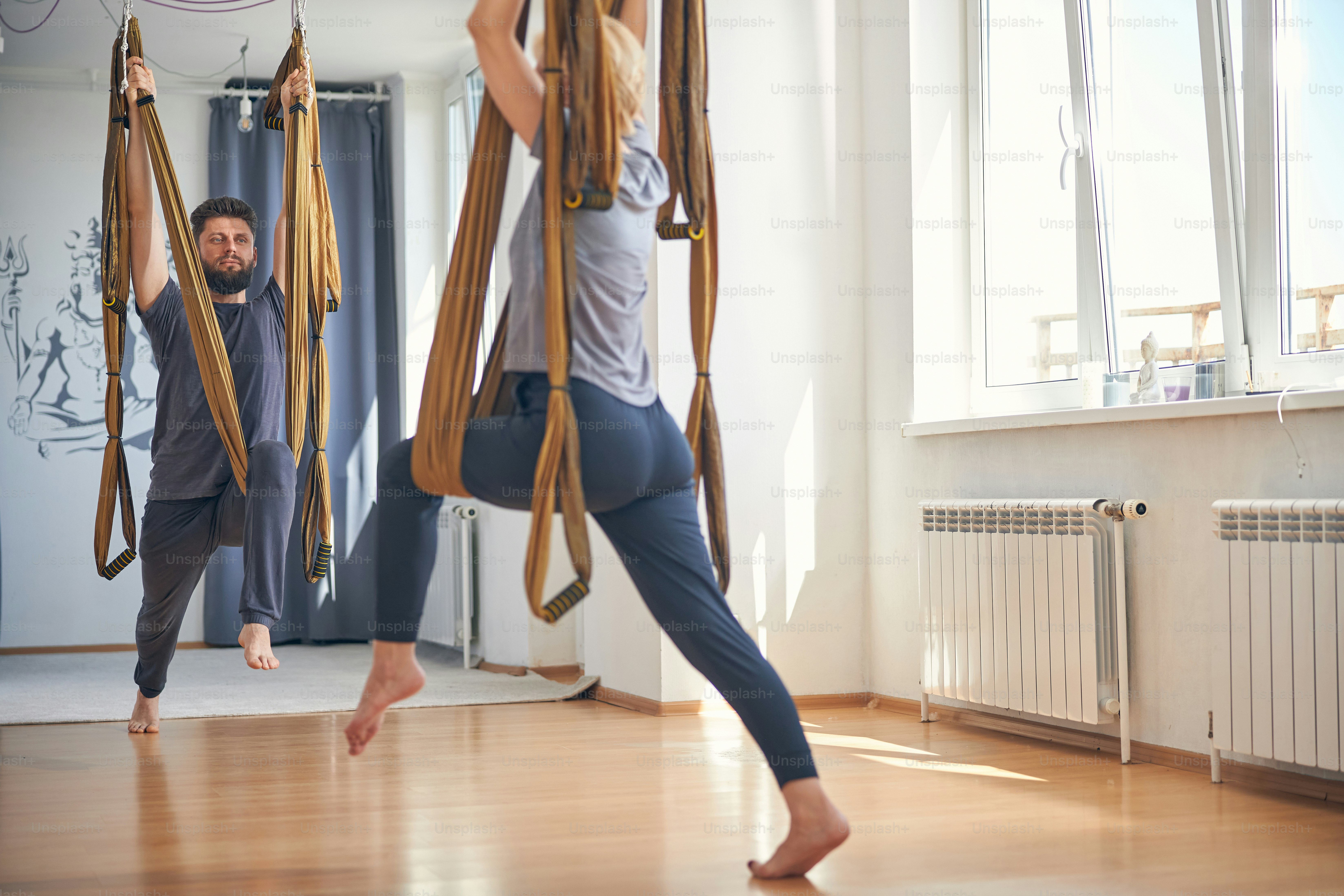 Serene young Caucasian professional trainer performing an aerial ...
