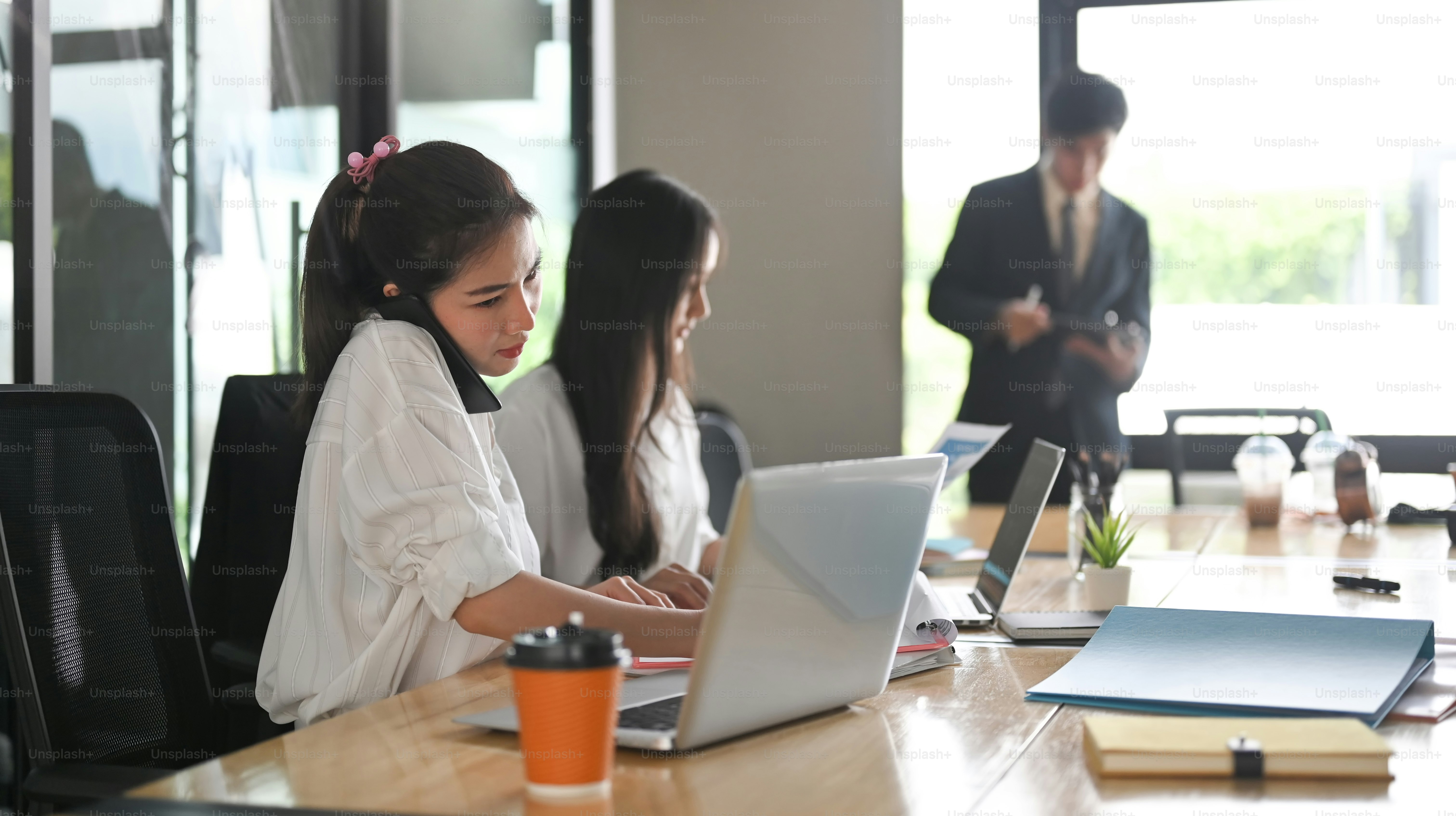 Comfortable business workspace is surrounding by a happy employee and ...