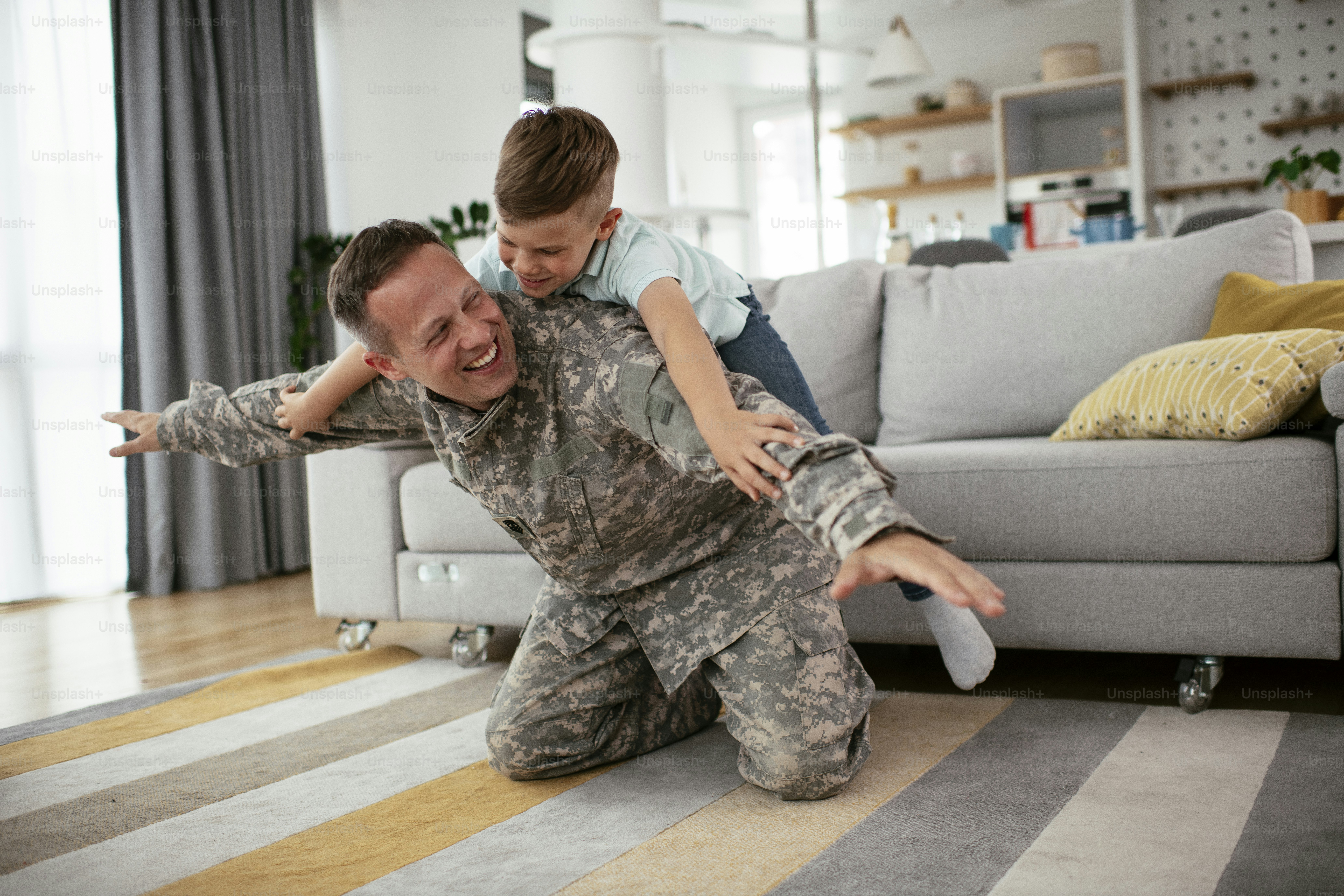 Happy soldier play with his son. Soldier enjoying at home with children ...