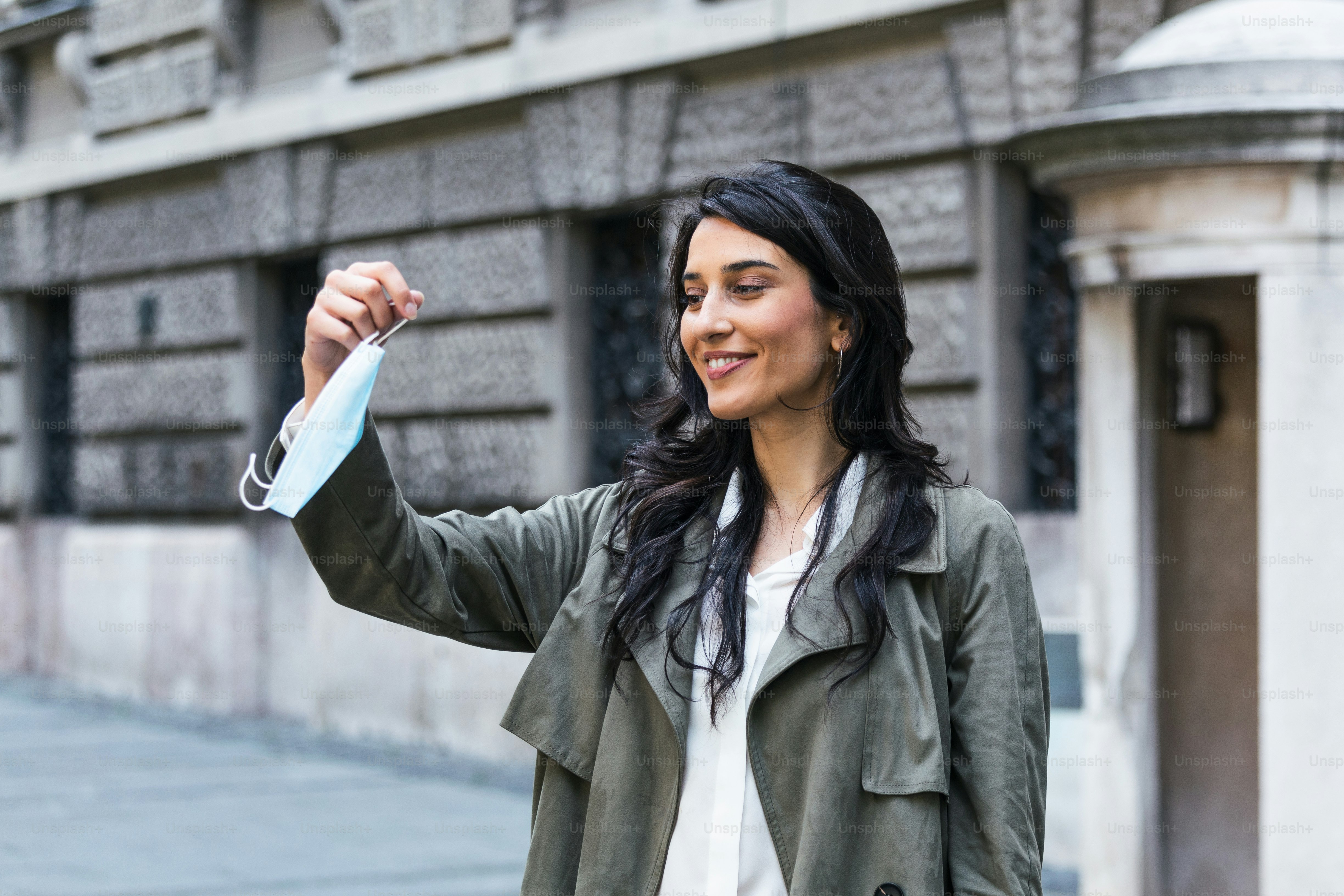 Quarantine is over concept. Woman taking off mask outdoor. We are safe ...