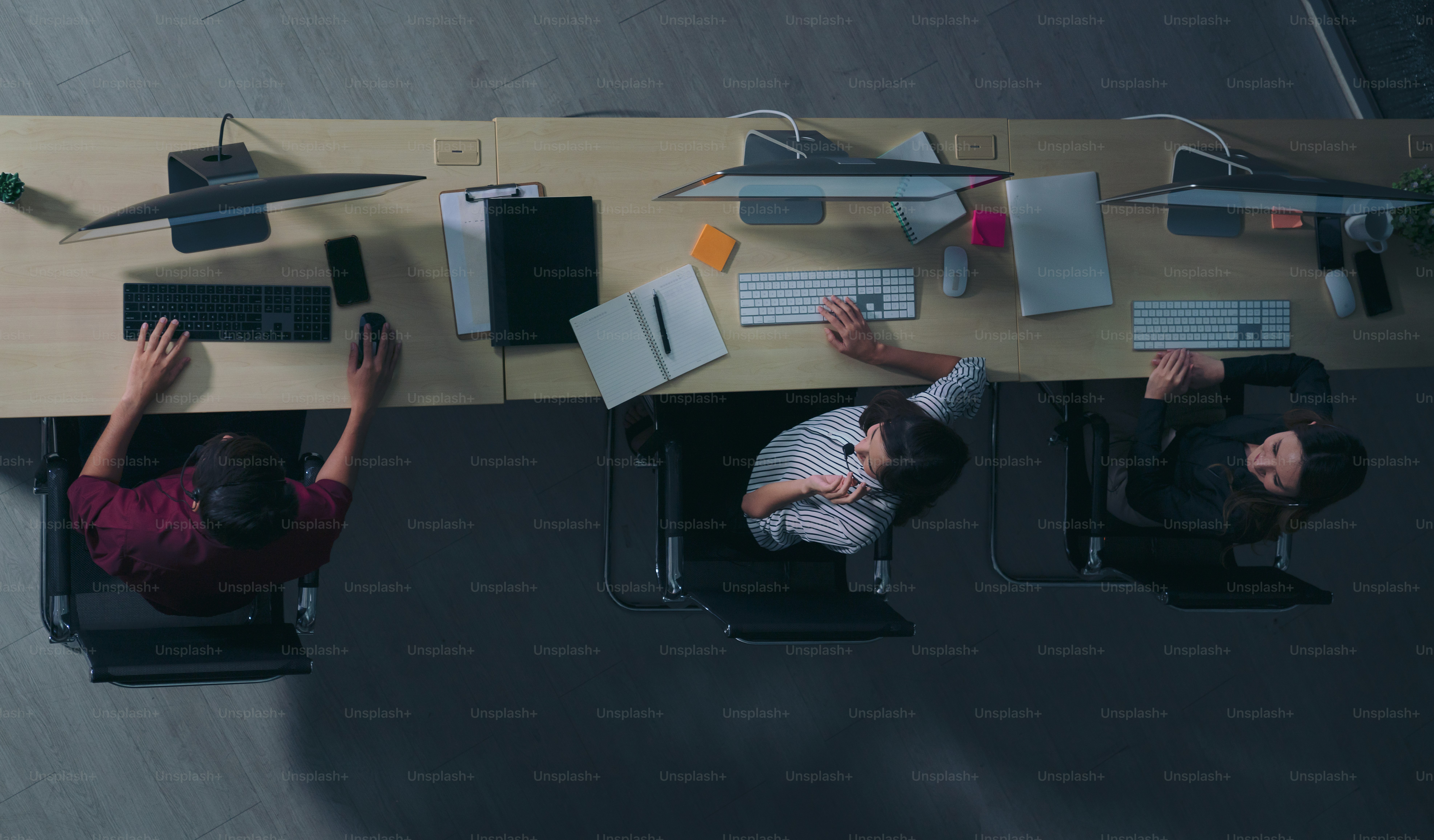 Top view young customer services care operators working night shift in ...
