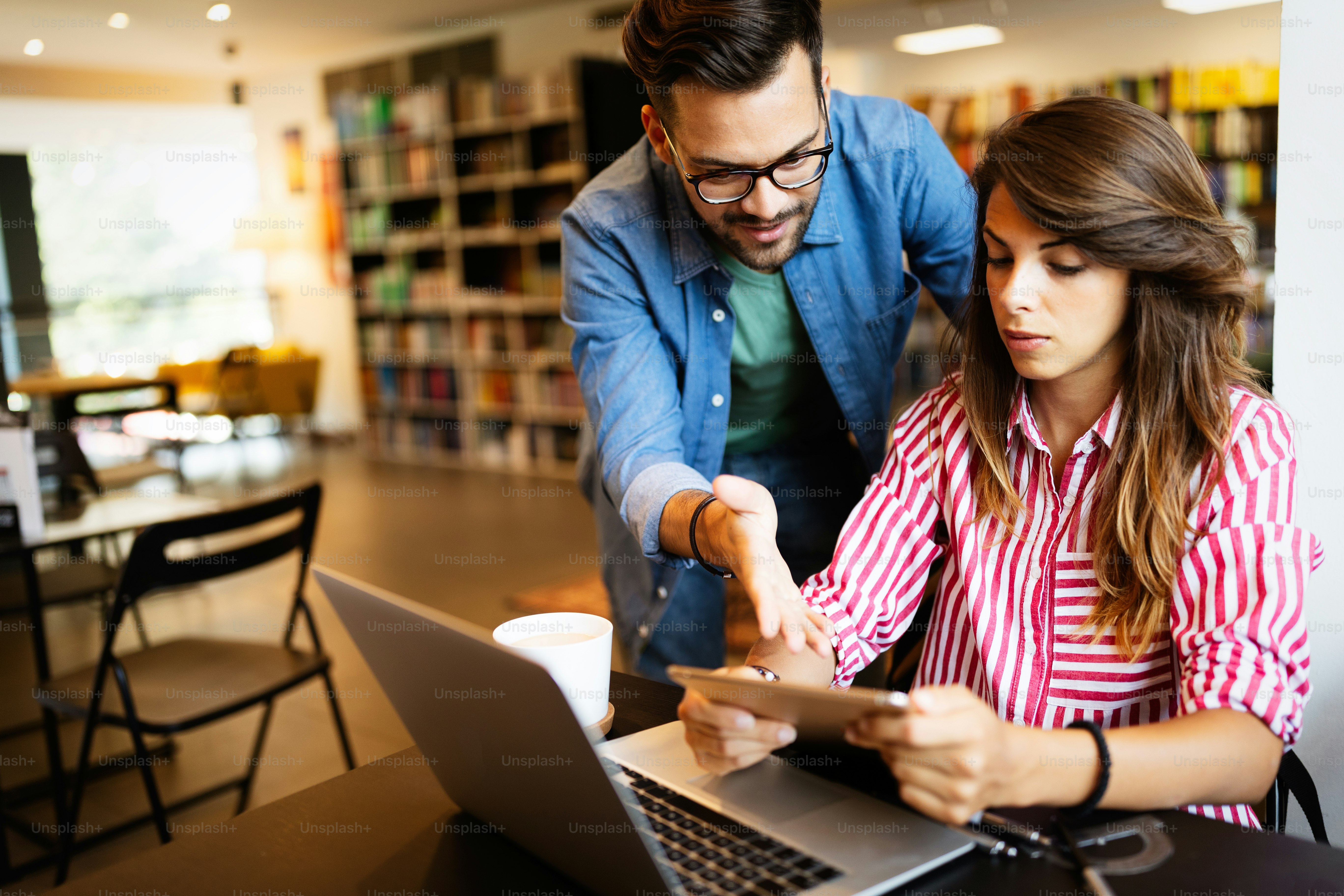 Happy young people working together on laptop. Teamwork, study ...