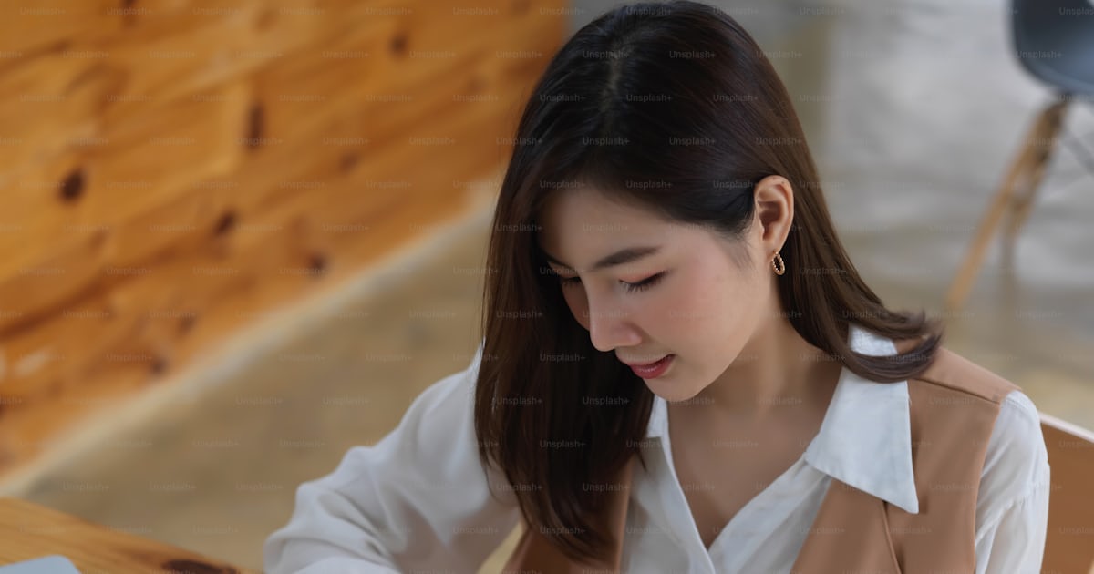 카페에서 일하는 동안 모형 태블릿을 사용하고 음료 한 잔을 들고 있는 여학생의 상위 뷰 사진 Unsplash의 태국 이미지