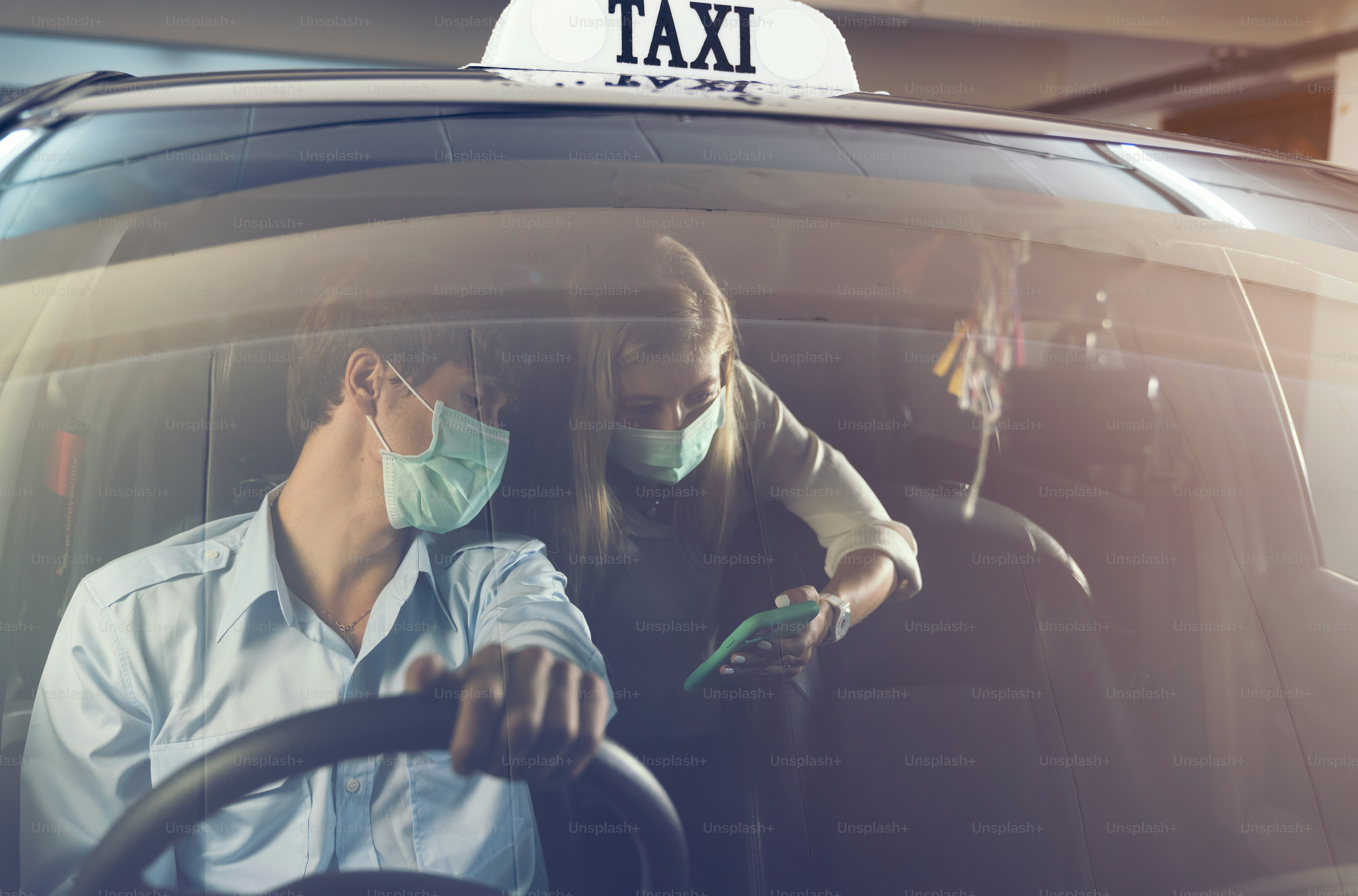 New normal. Teenager sitting in the back of a car with a mask. Young ...