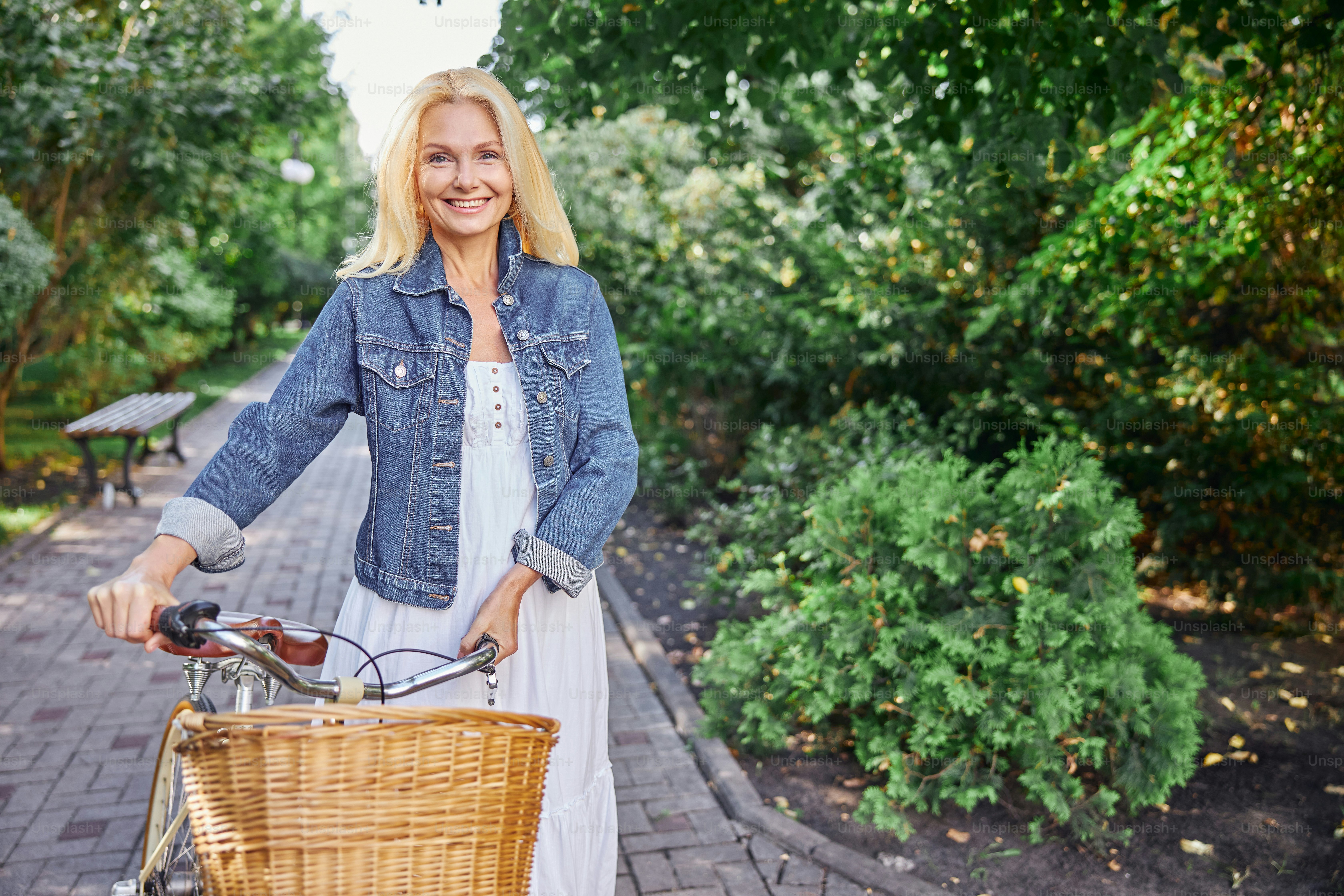Close up portrait of happy cheerful lady in denim jacket and white ...