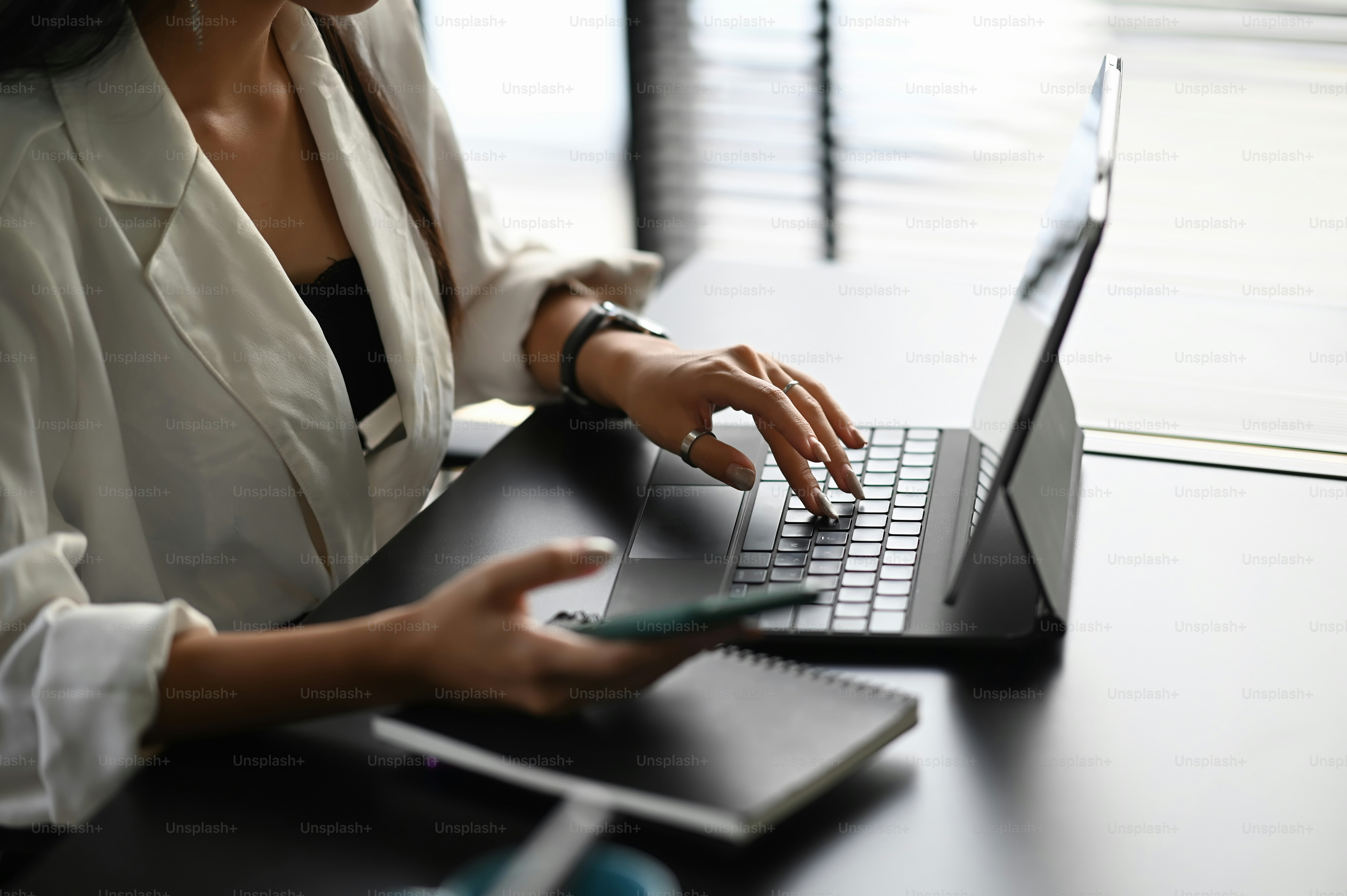 Cropped shot of businesswoman working on mock up tablet while using ...