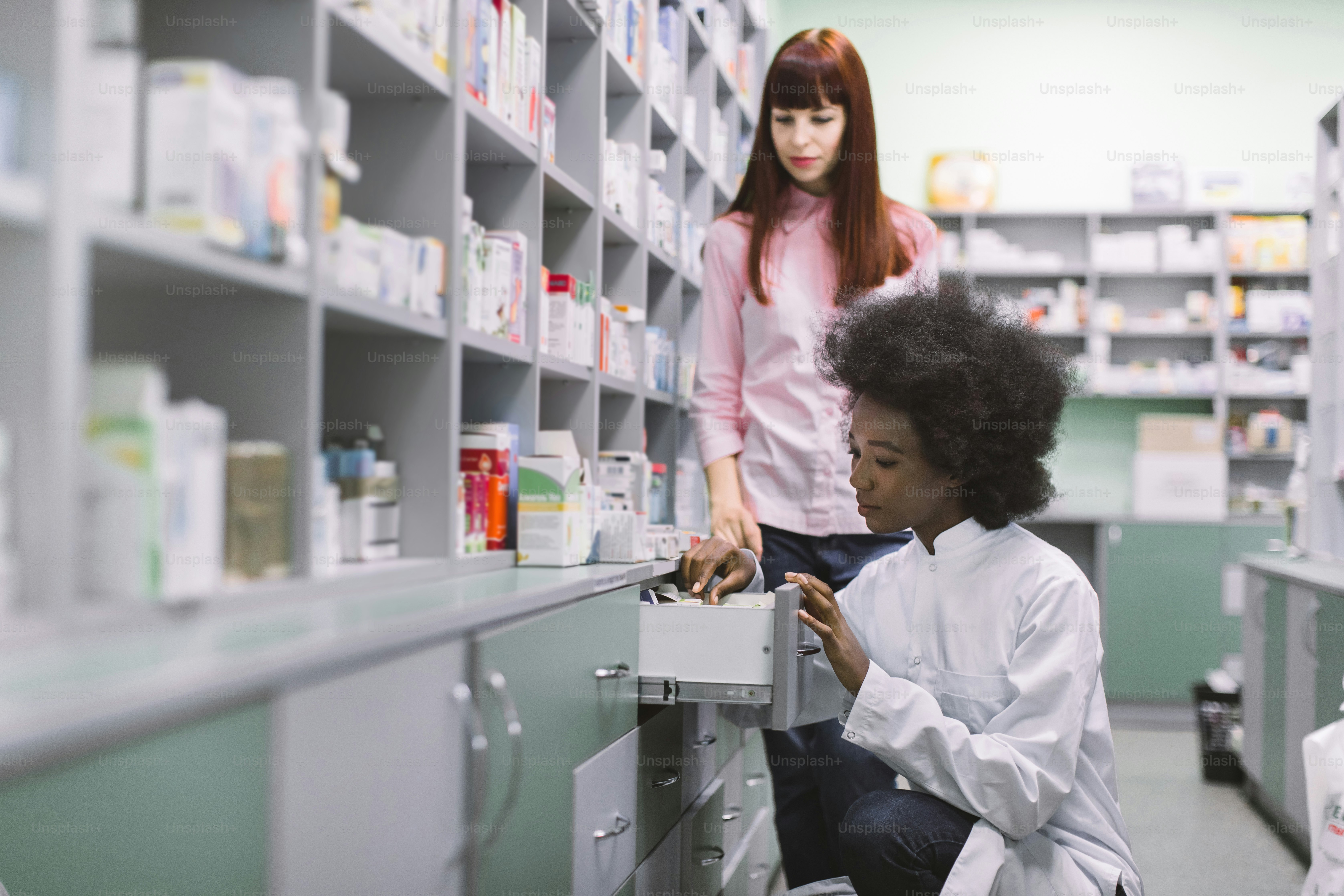 Pretty young smiling woman, buying medicines at the drugstore., while ...