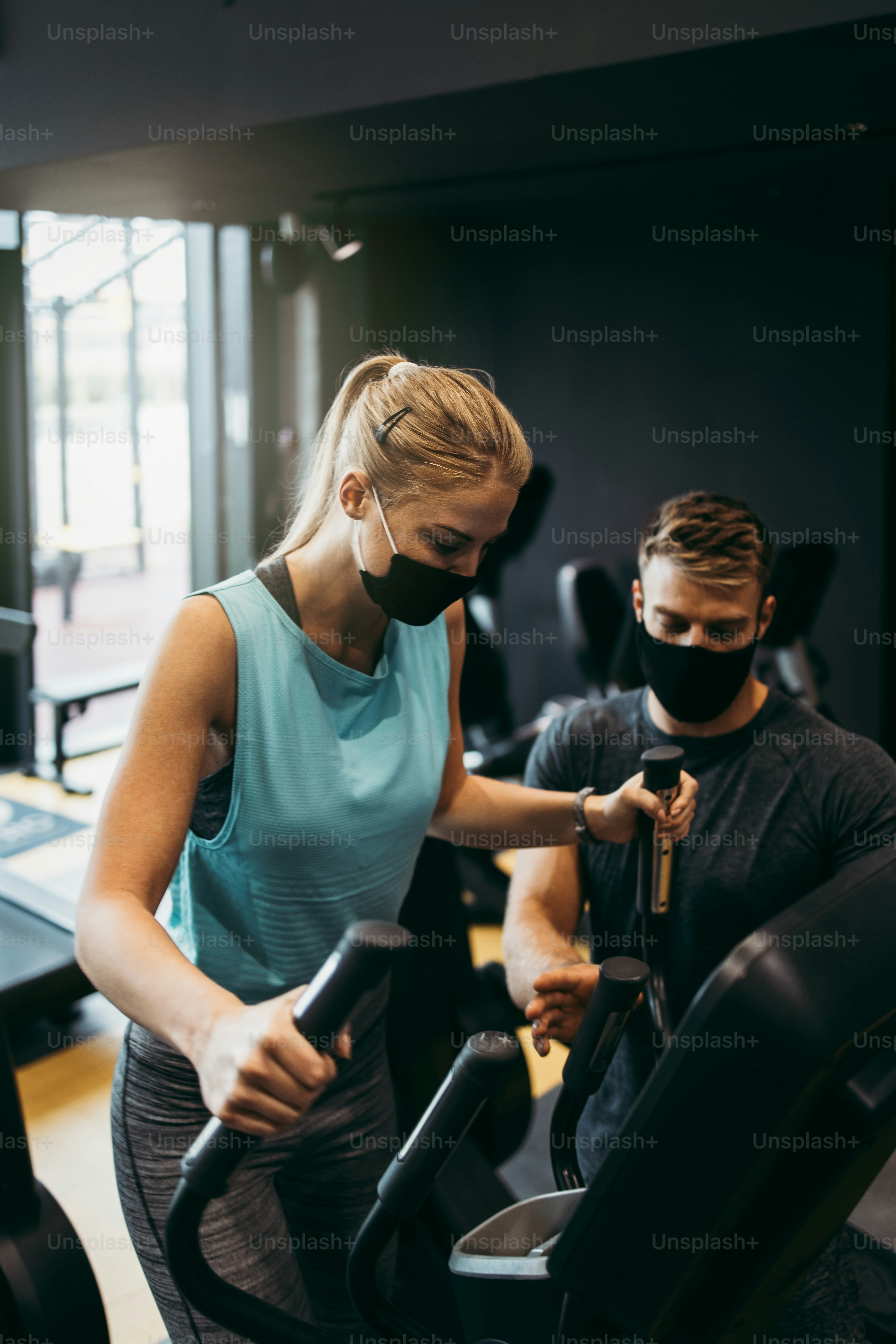 Young fit and attractive woman at body workout in modern gym together ...