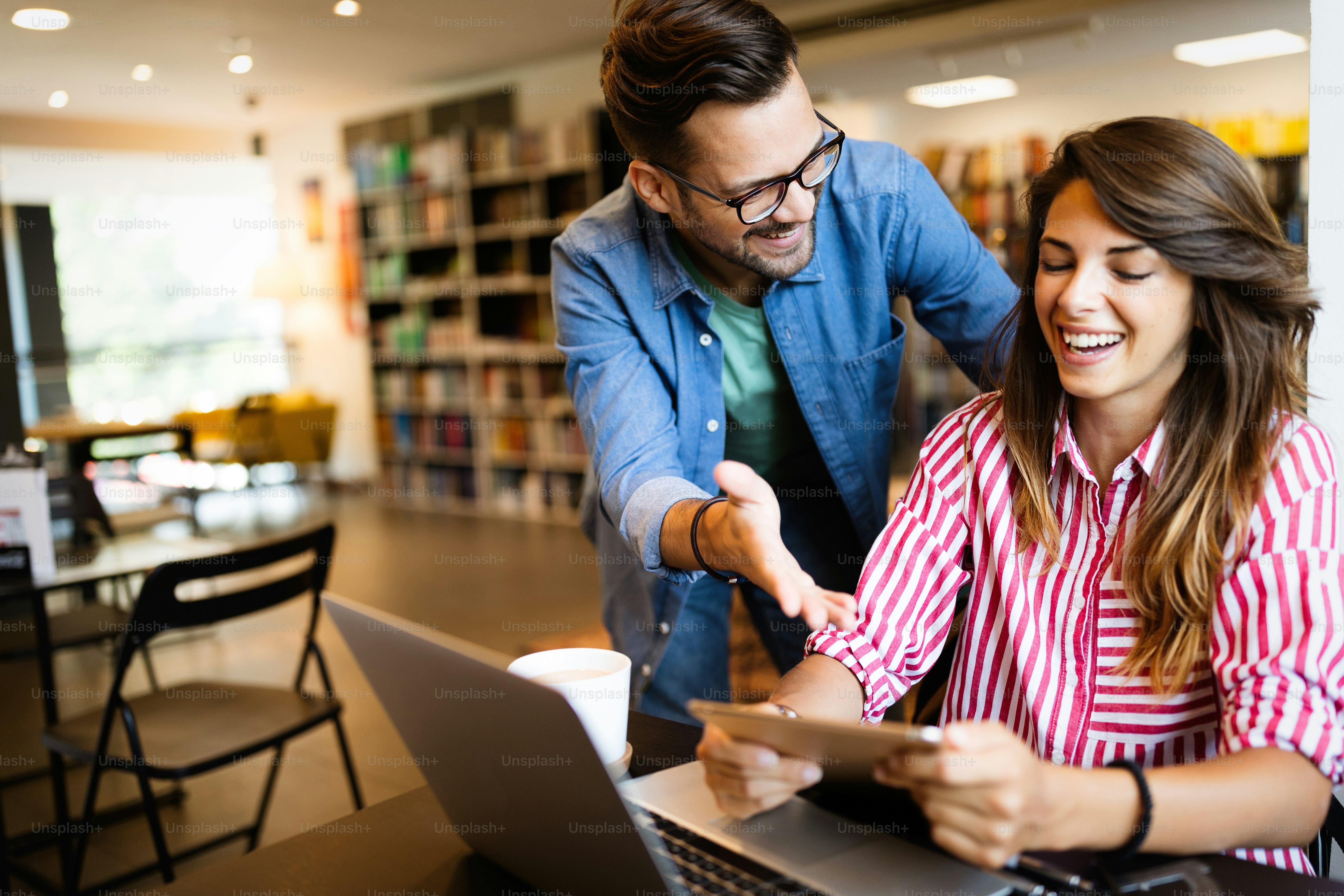 Happy young people working together on laptop. Teamwork, study ...