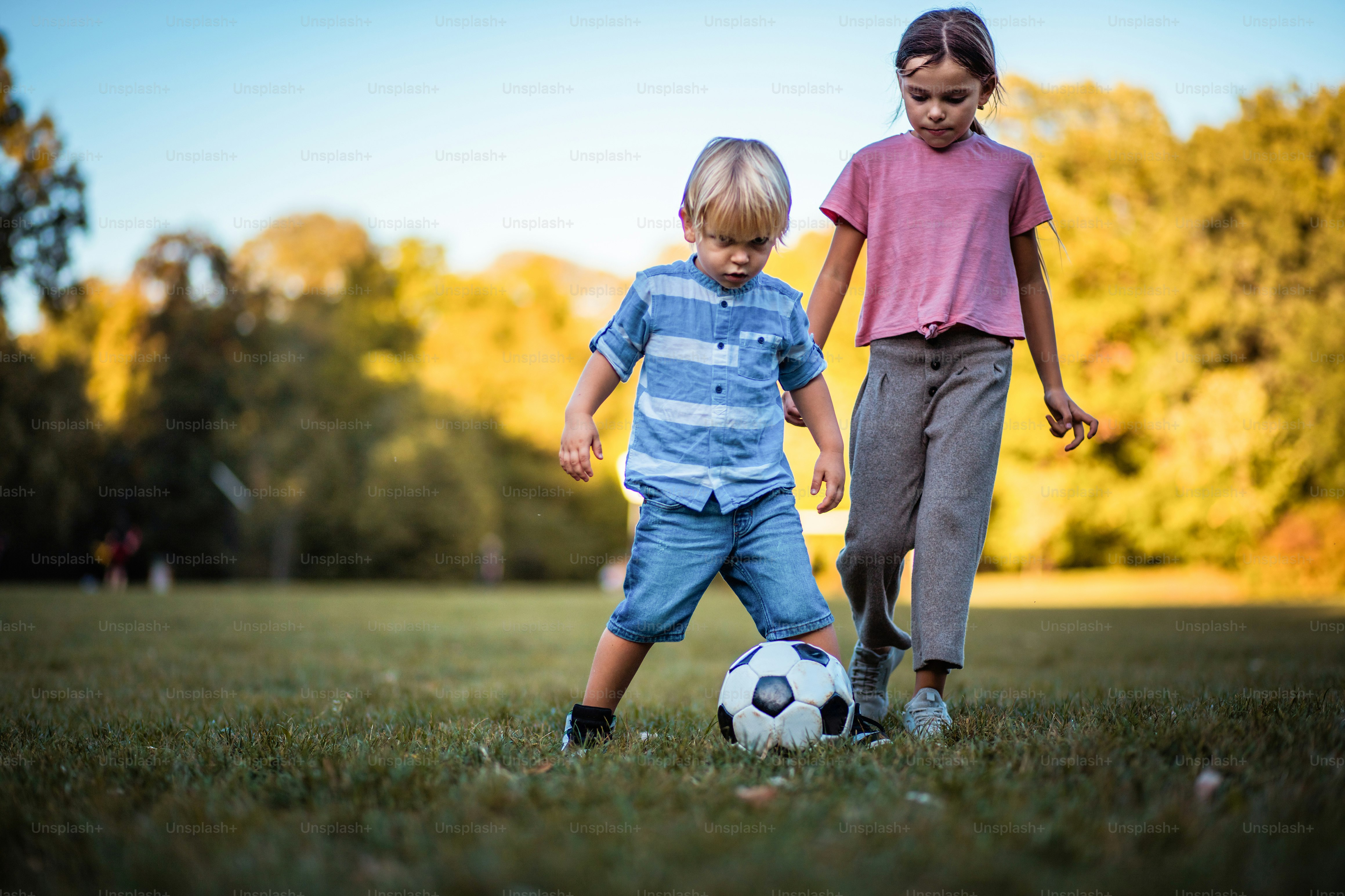 Competition. Sister and brother playing football. photo – People Image ...