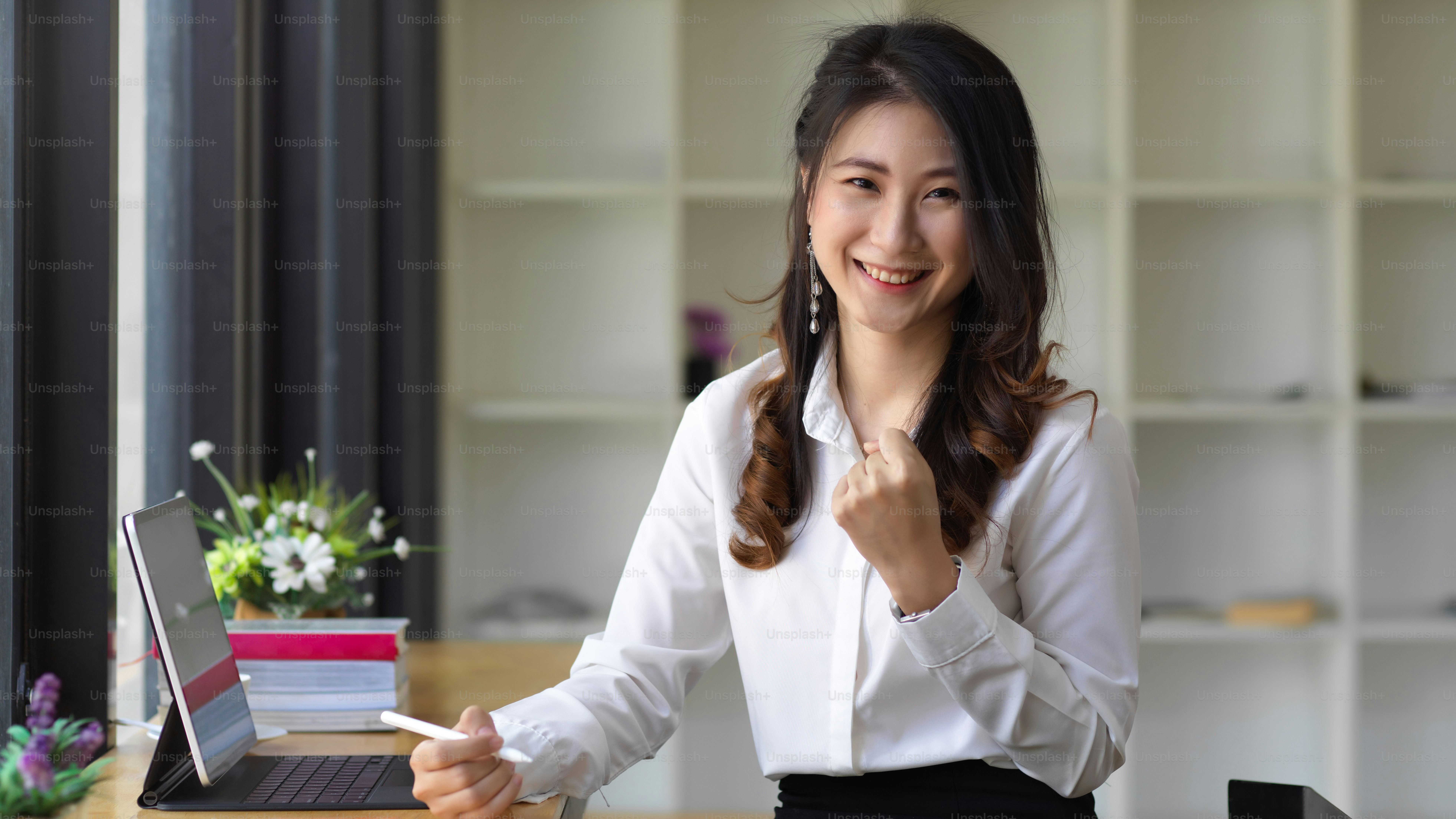 Portrait of female college student smiling to camera while sitting in ...
