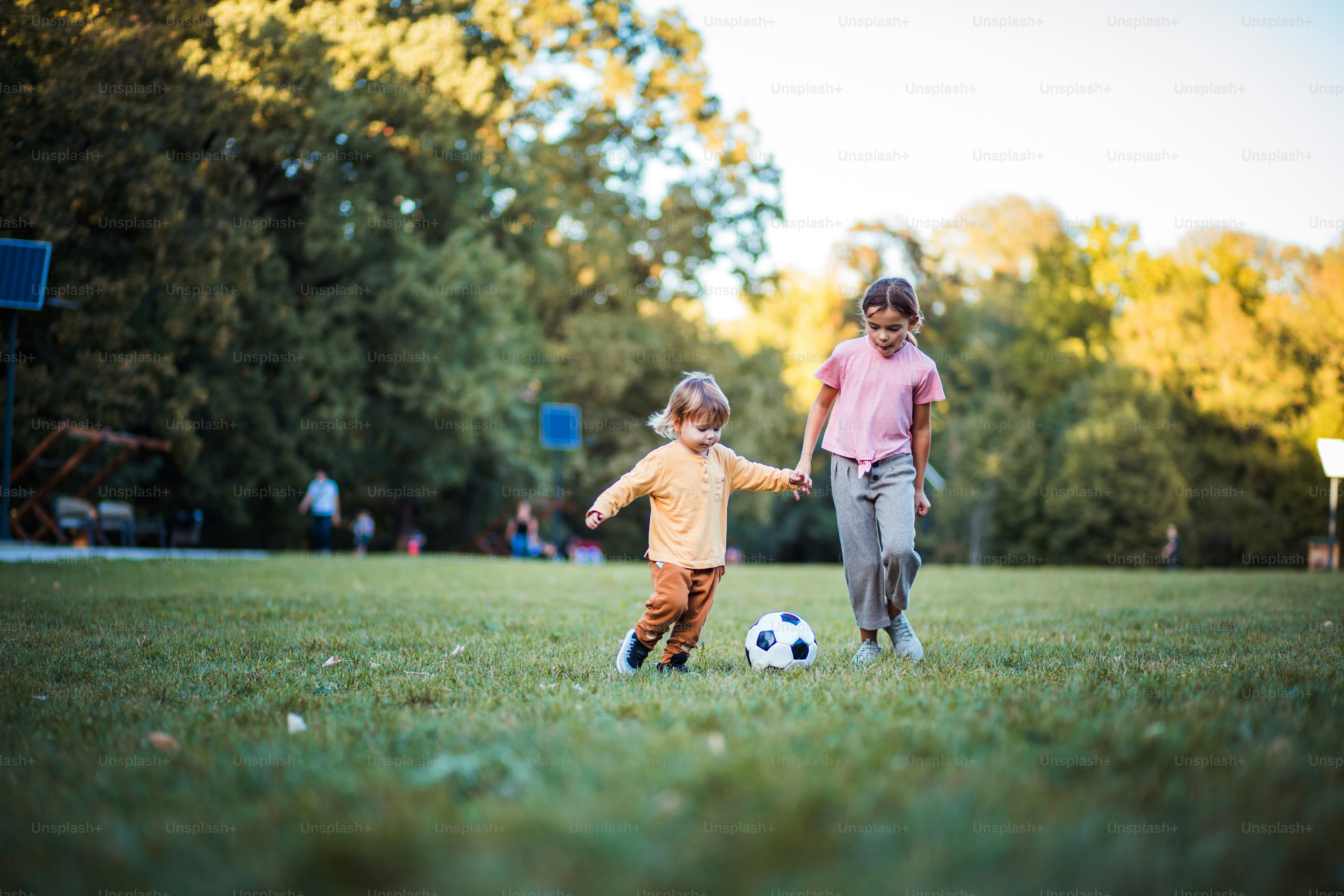 Football time. Sister and brother playing football. photo – Friendship ...