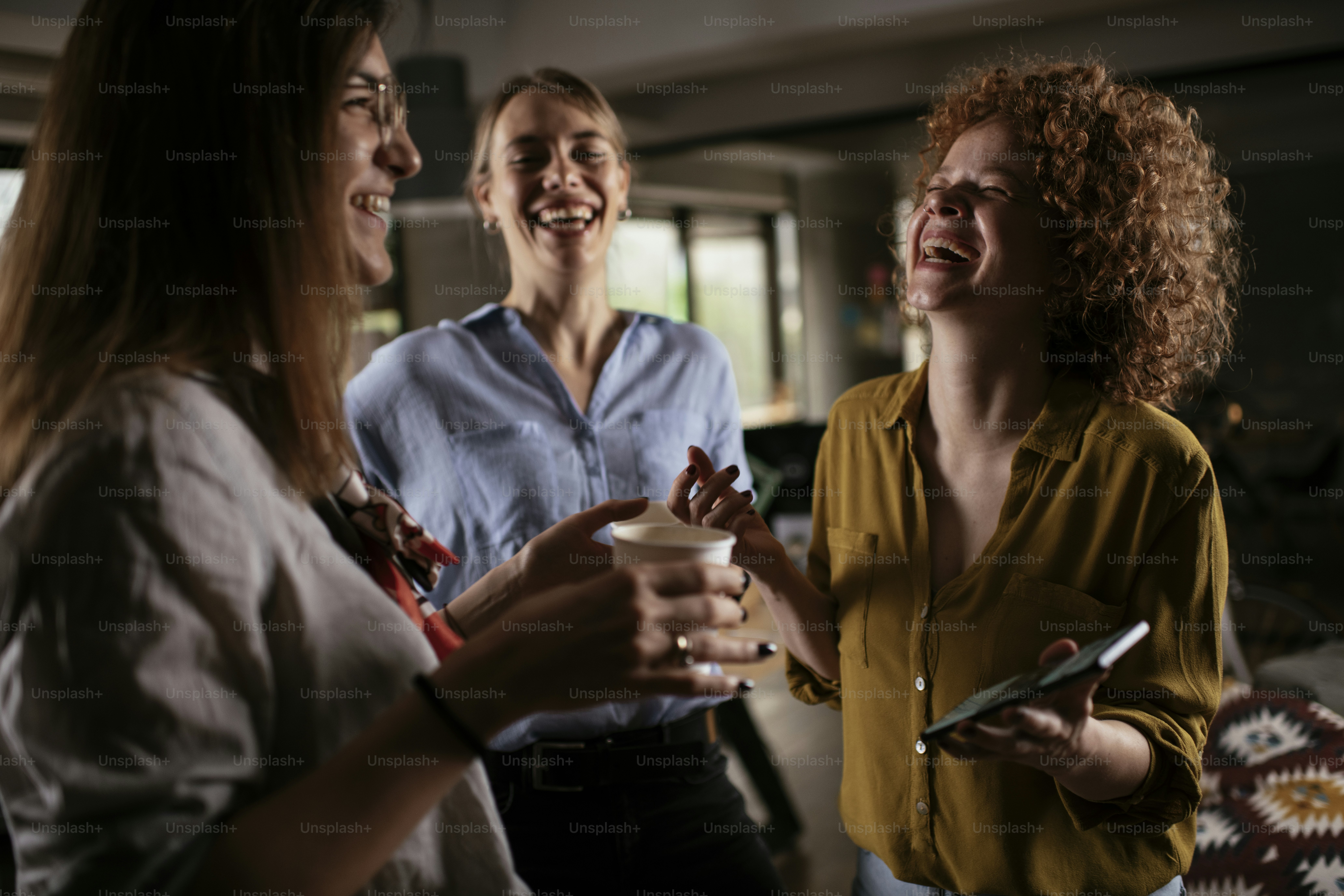 Colleagues in office talking and having fun. Friends working together ...