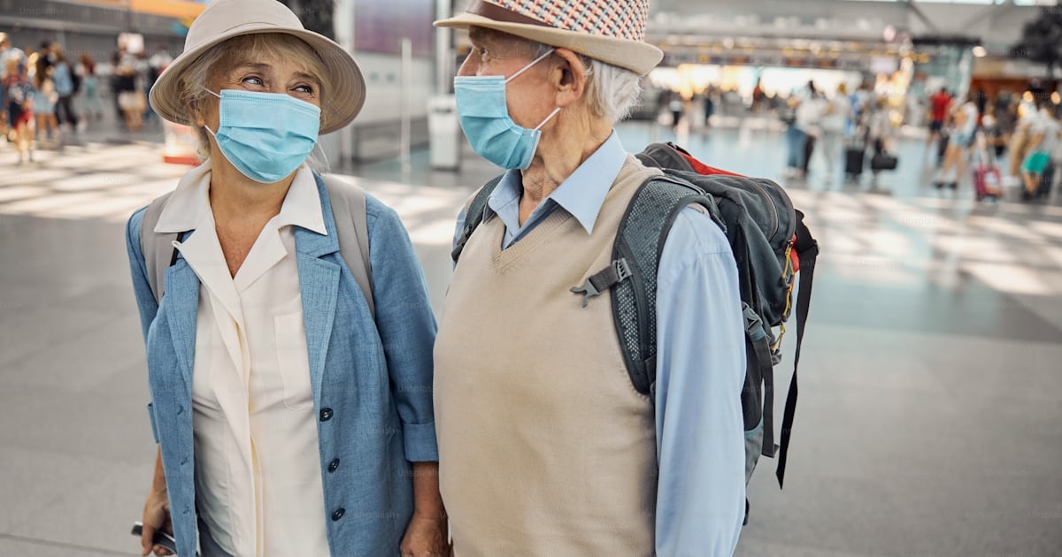 Smiling Elderly Lady With A Boarding Ticket And A Foreign Passport