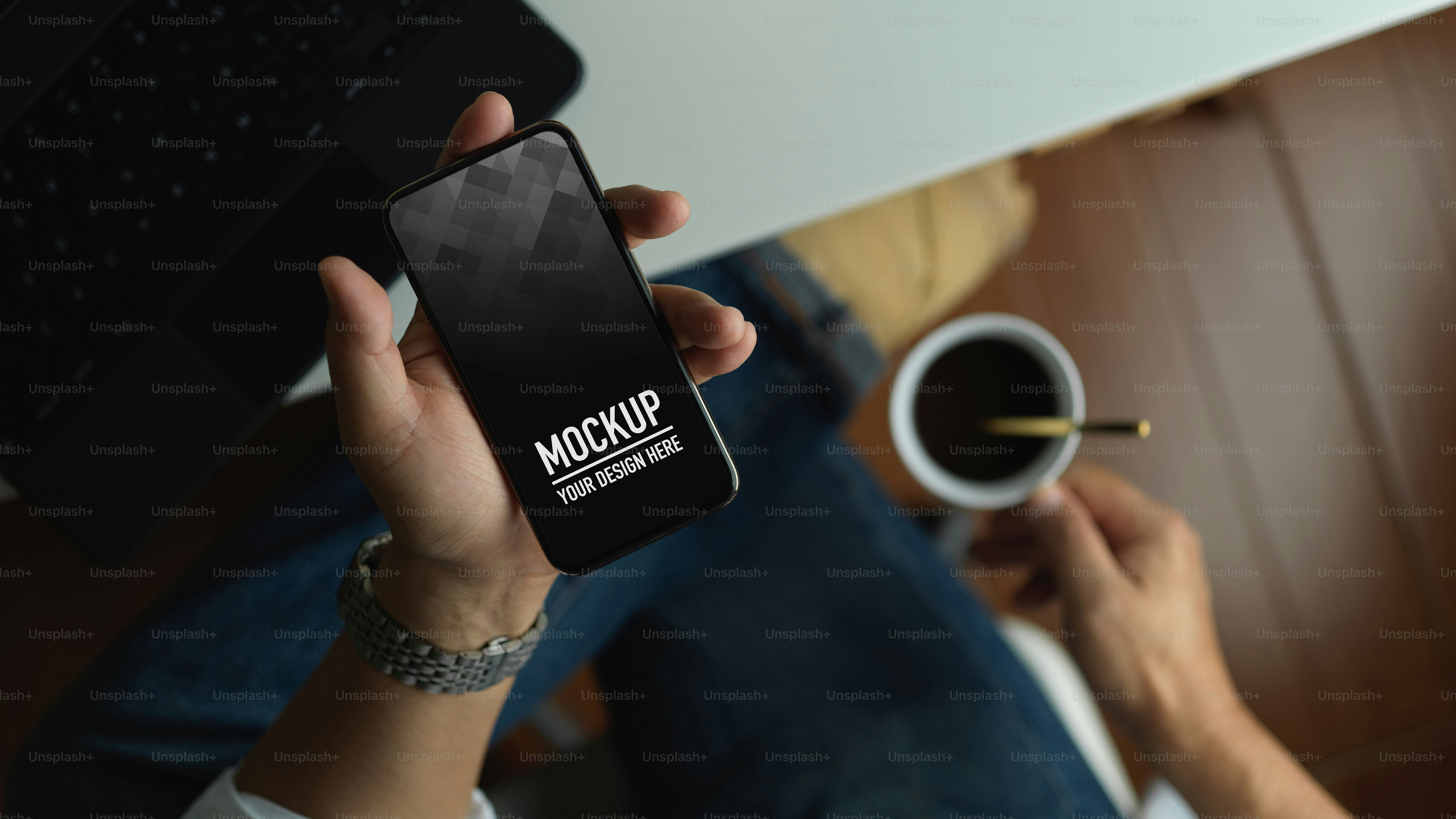 Top view of man holding mock up smartphone while drinking coffee in ...
