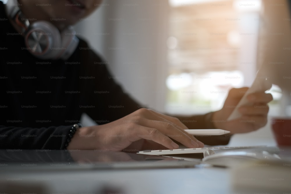 Cropped shot of young graphic designer sitting at graphic studio in ... Cropped shot of young graphic designer sitting at graphic studio in ...