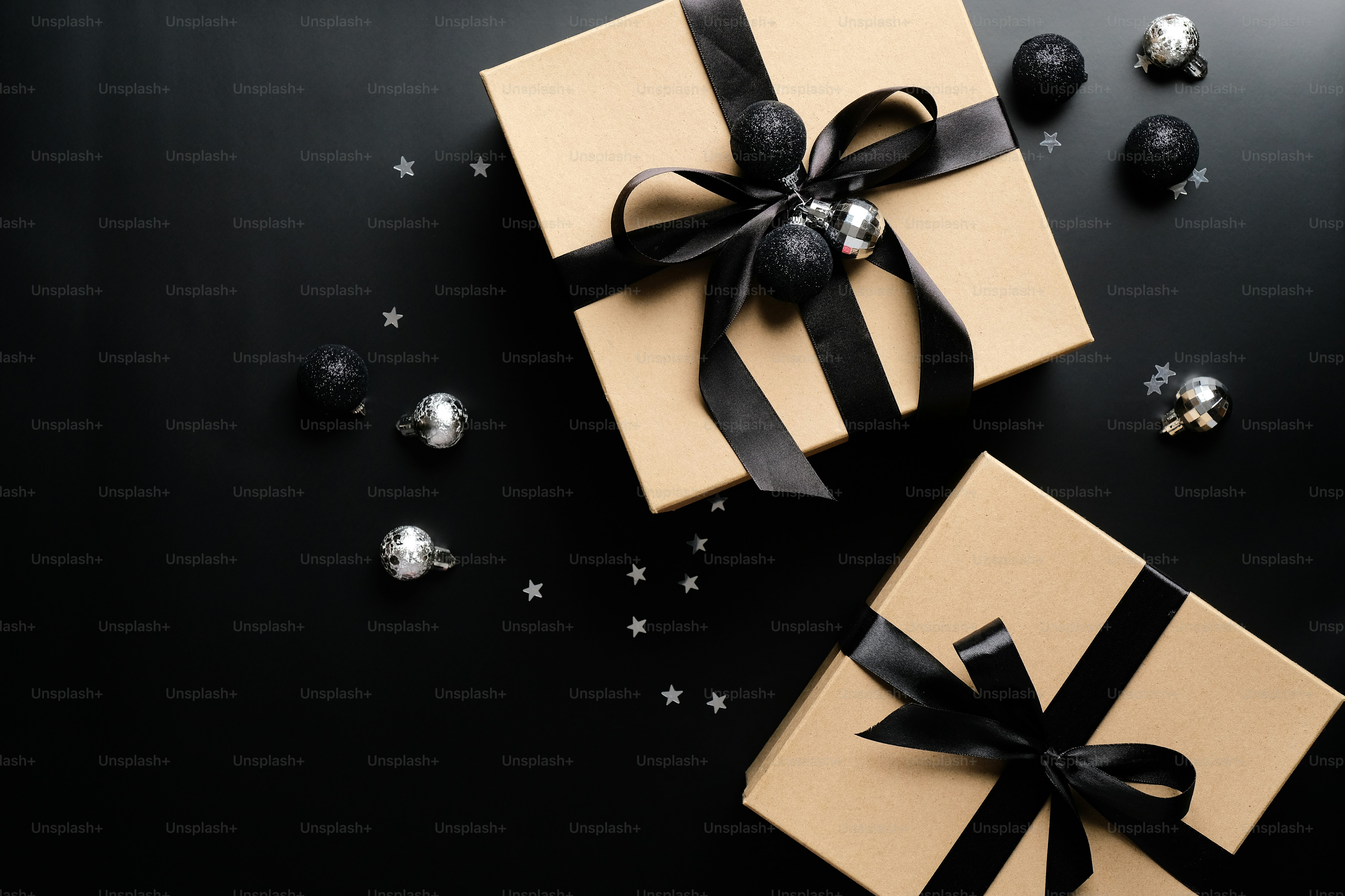 Elegant Christmas present boxes and balls on black background. Flat lay ...