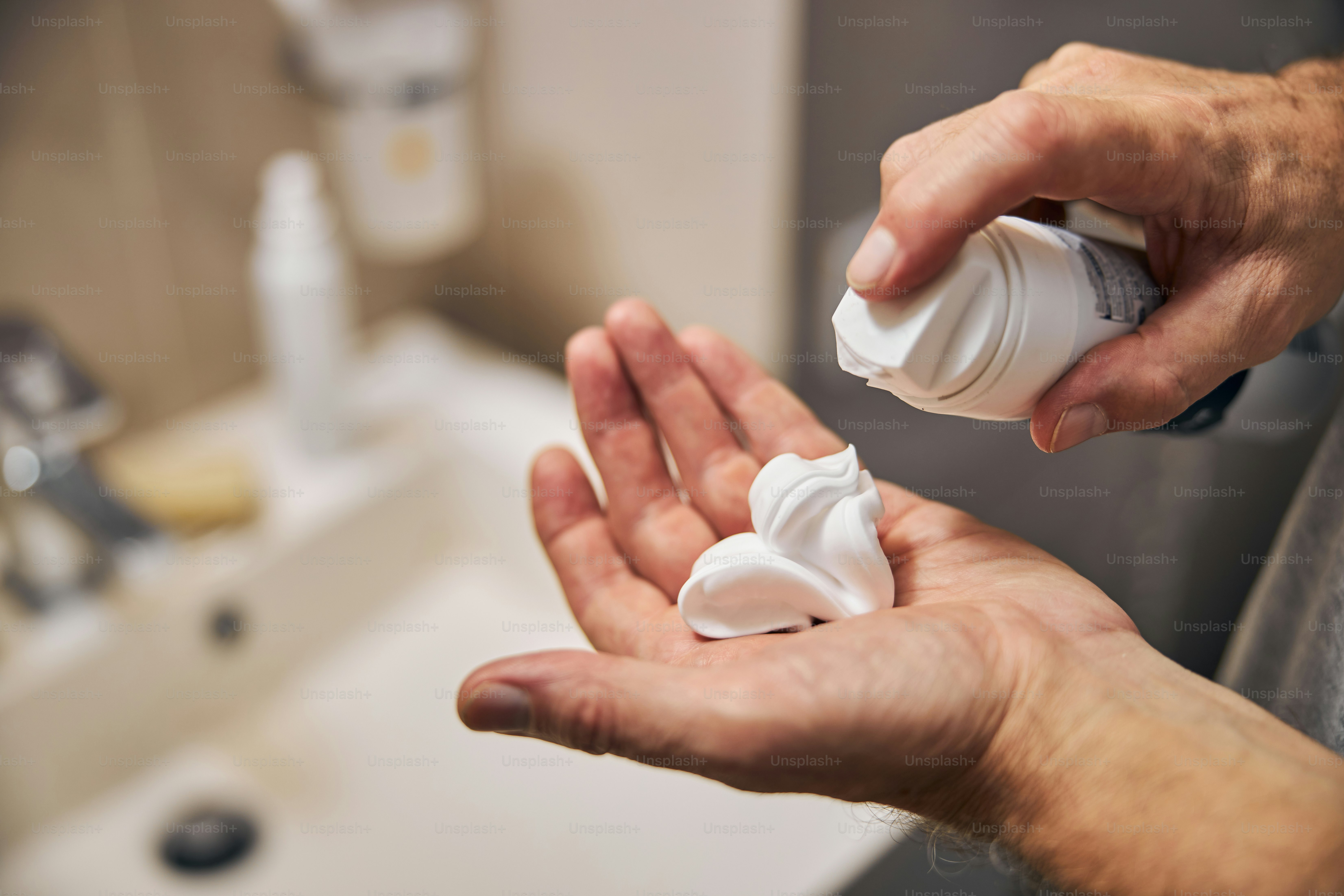 Cropped photo of person squeezing some shaving foam out of a spray can ...