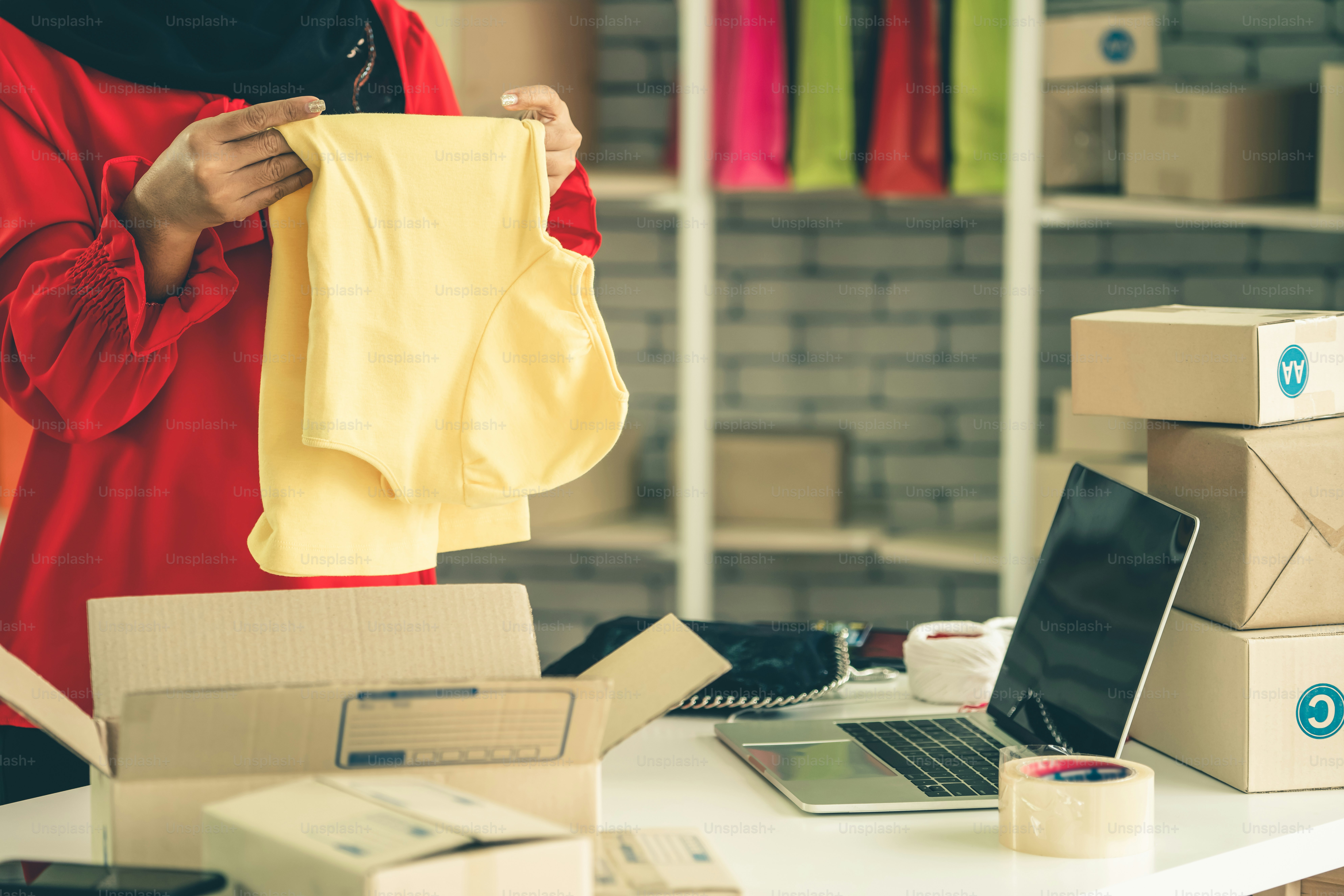 Online seller works at home office and packs shipping delivery box to ...