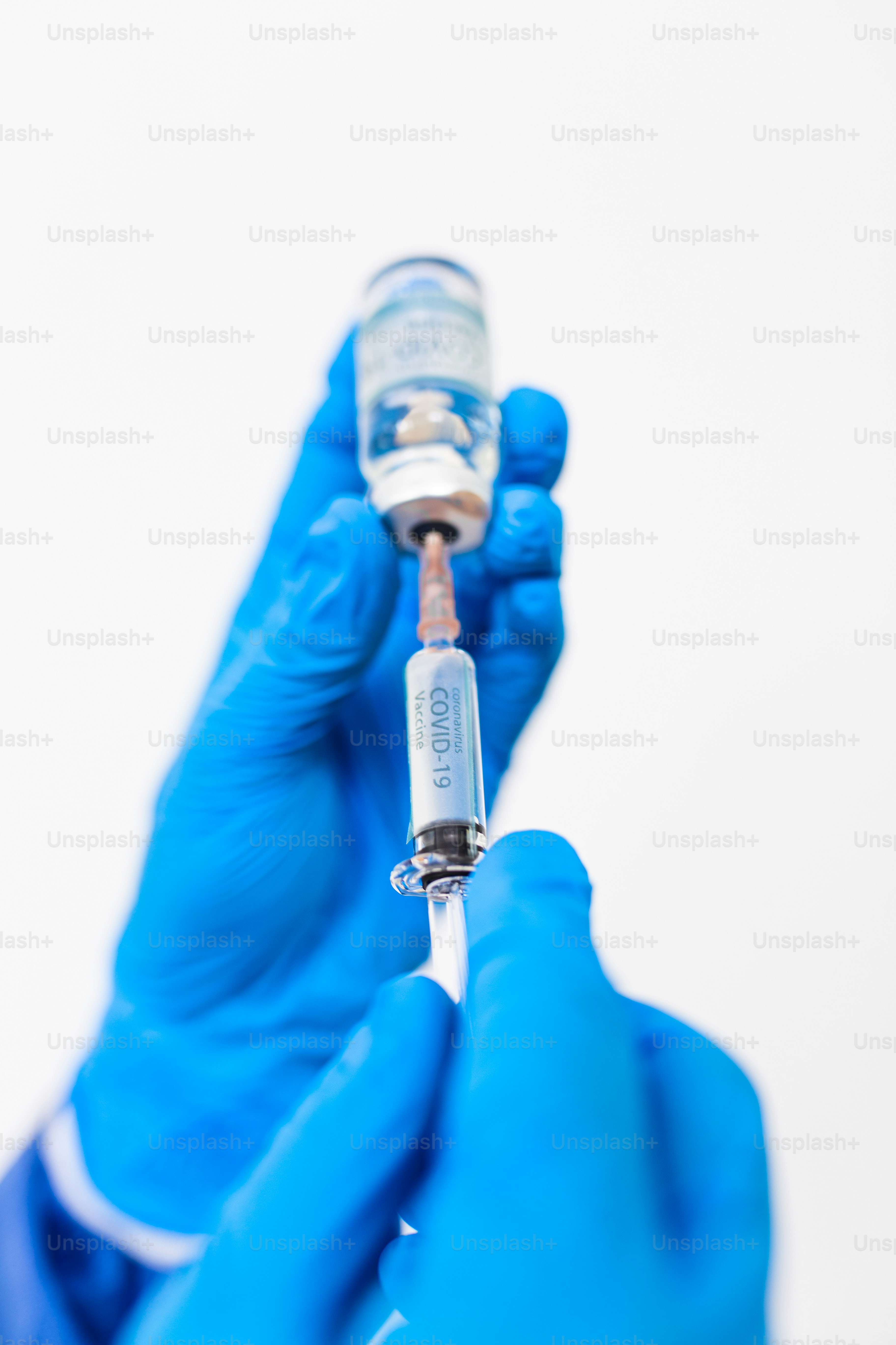 Doctor or nurse wearing ppe suit in hospital with an injection vaccine ...