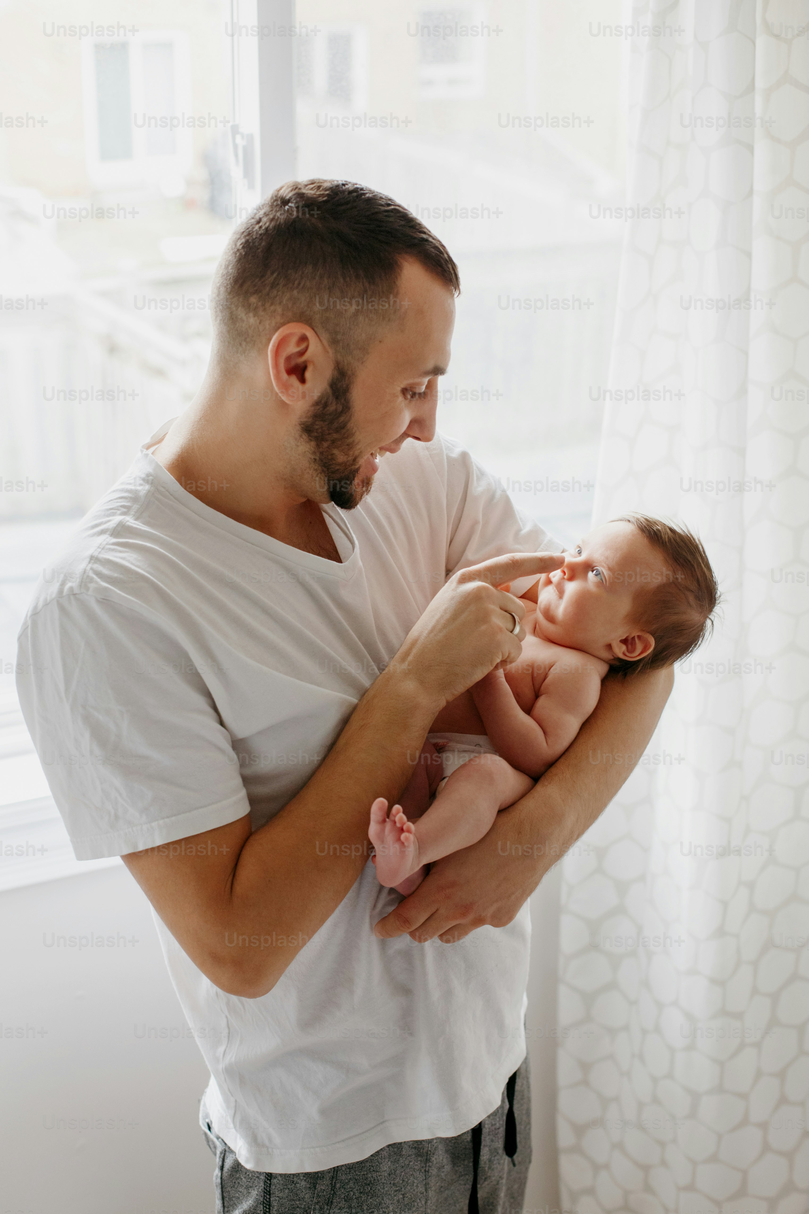 Happy Caucasian father holding newborn baby. Male man parent rocking ...