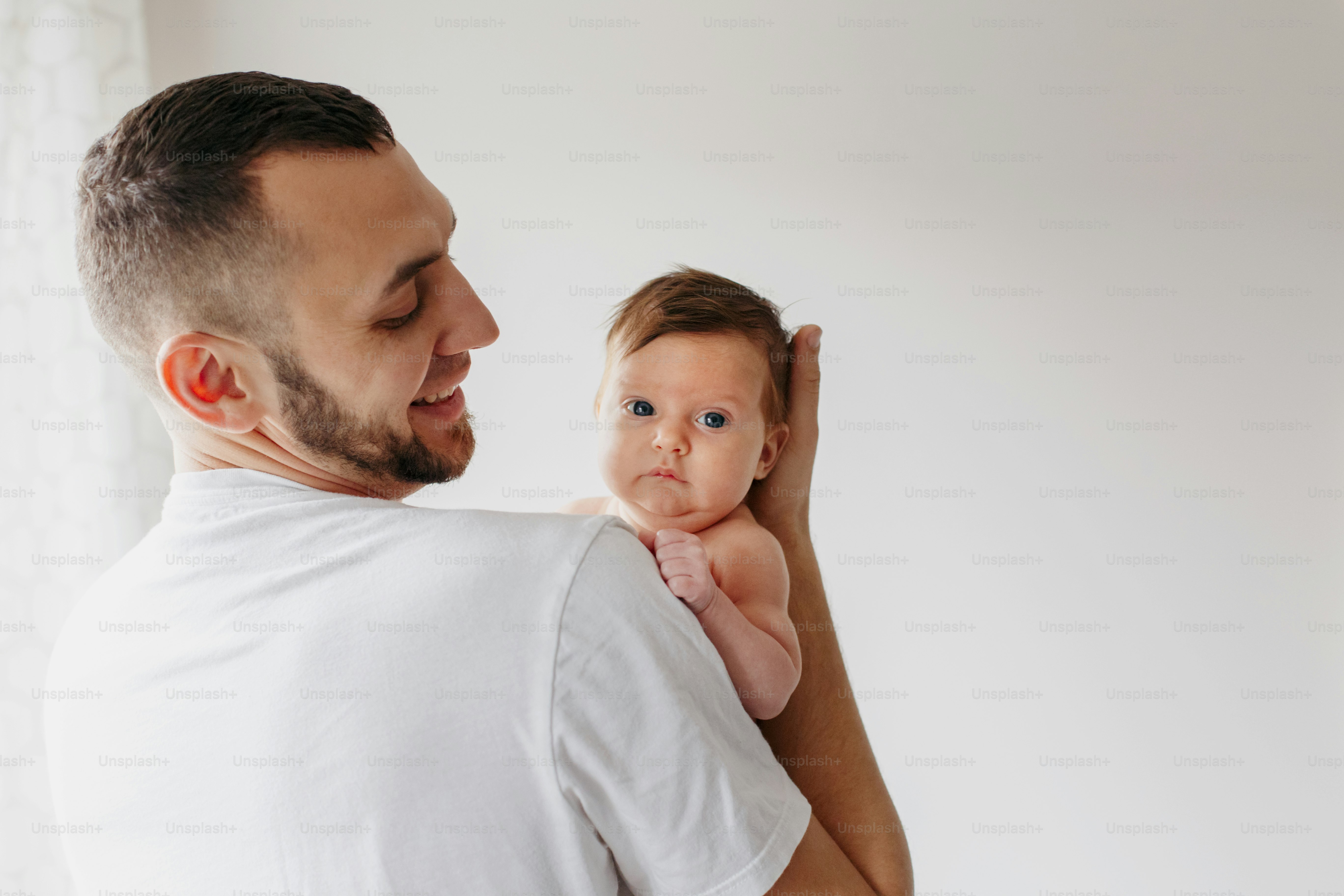 Happy Caucasian father holding newborn baby. Male bearded man parent ...