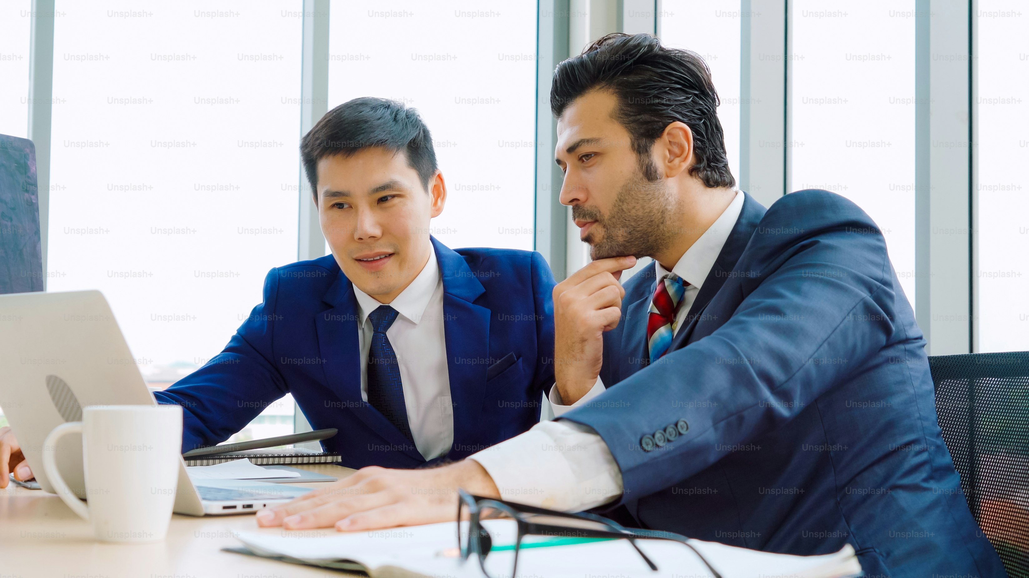 Two business people talk project strategy at office meeting room ...