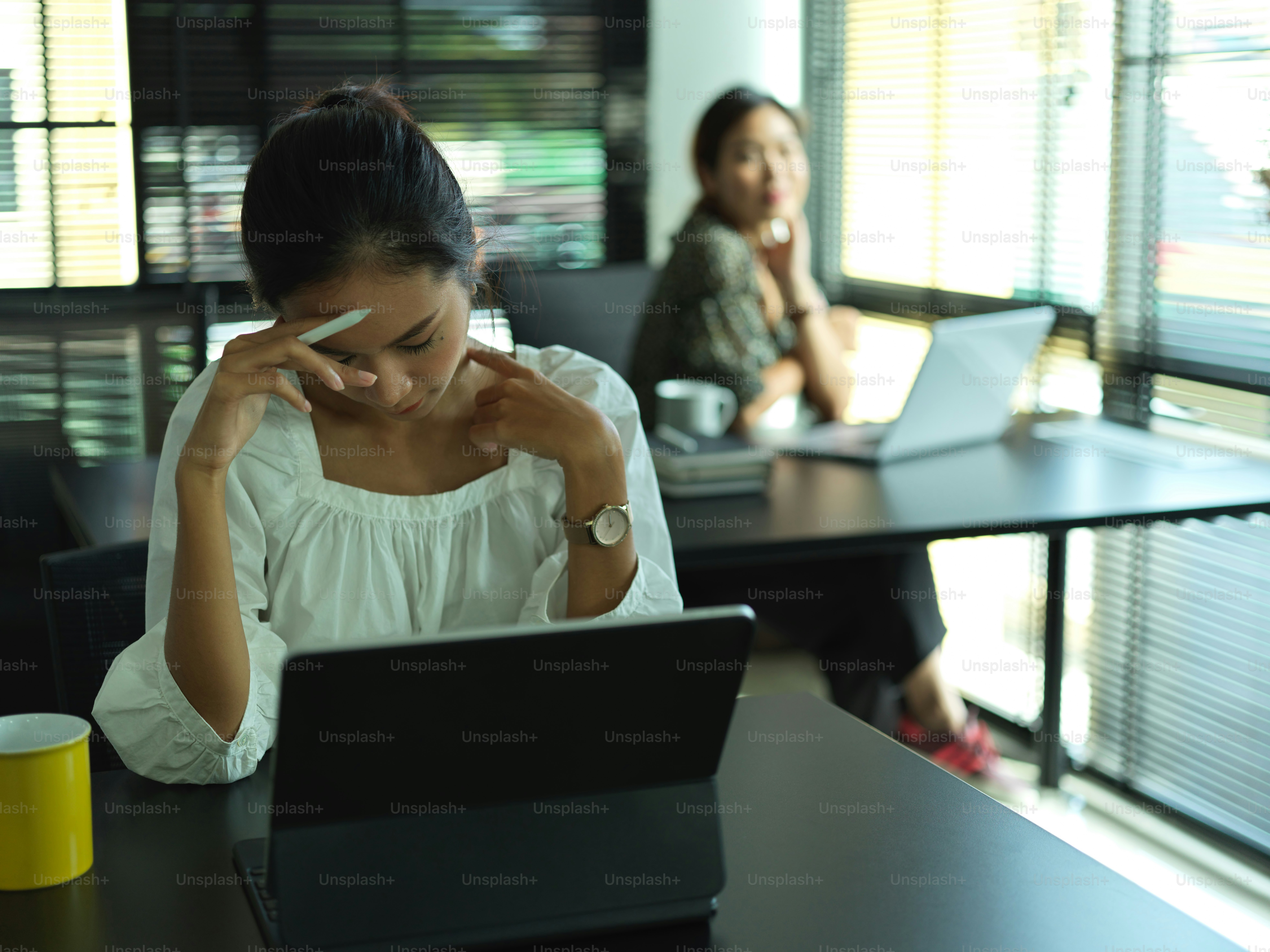 Close up view of businesswoman feeling stressed while working in office ...