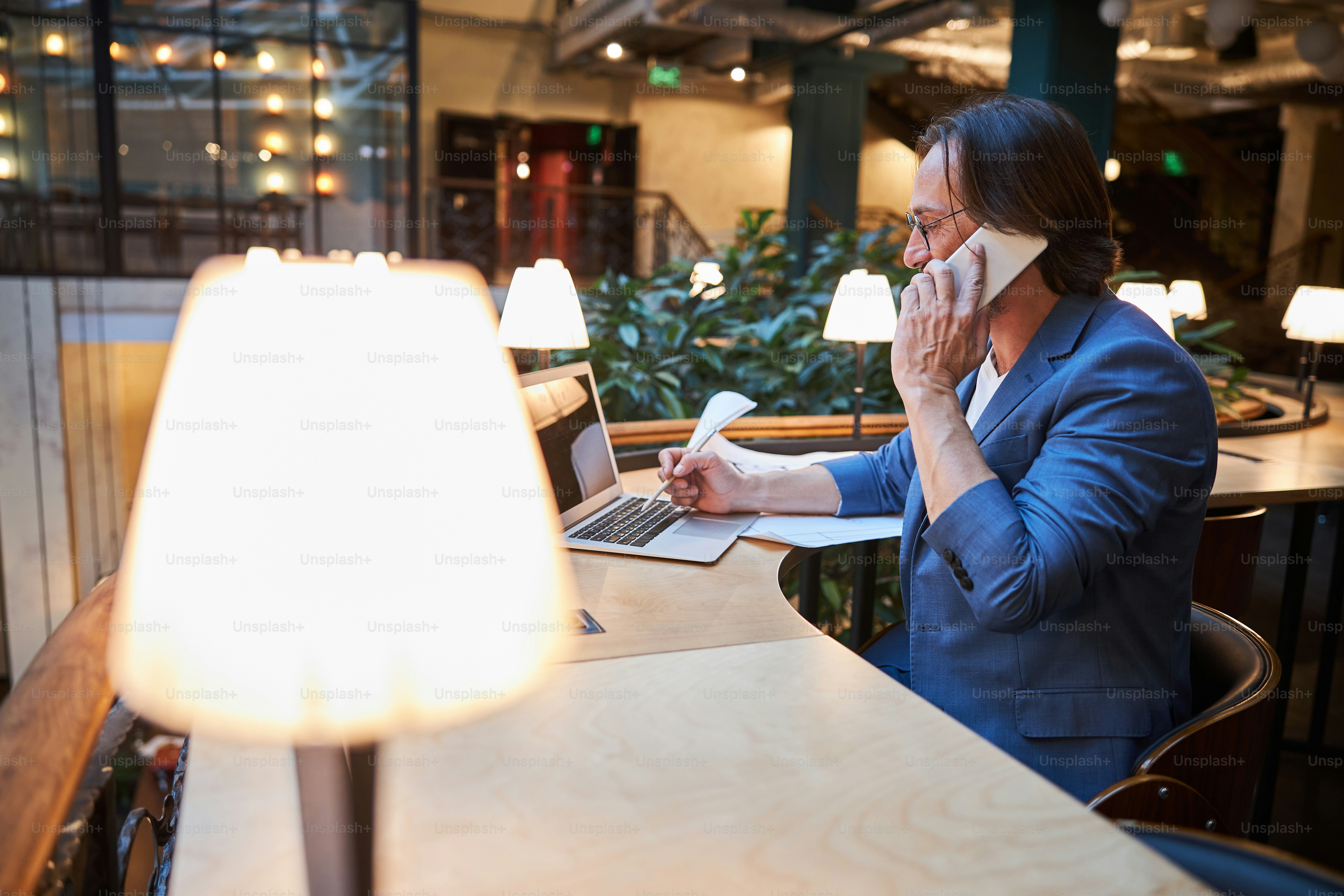 Shocked brunette man yelling with surprise while talking on the phone ...
