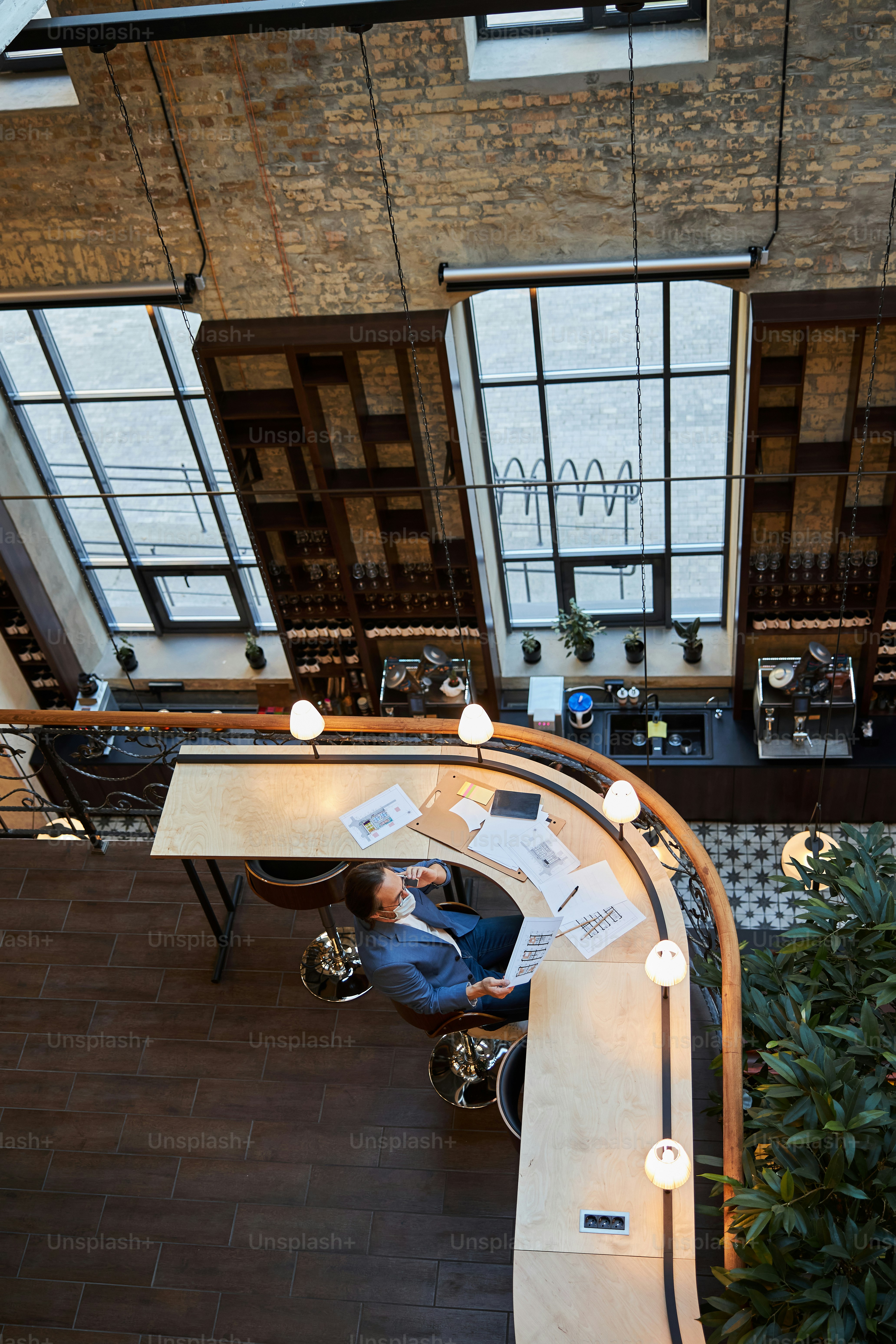 Responsible adult taking notes while sitting at the bar counter and ...