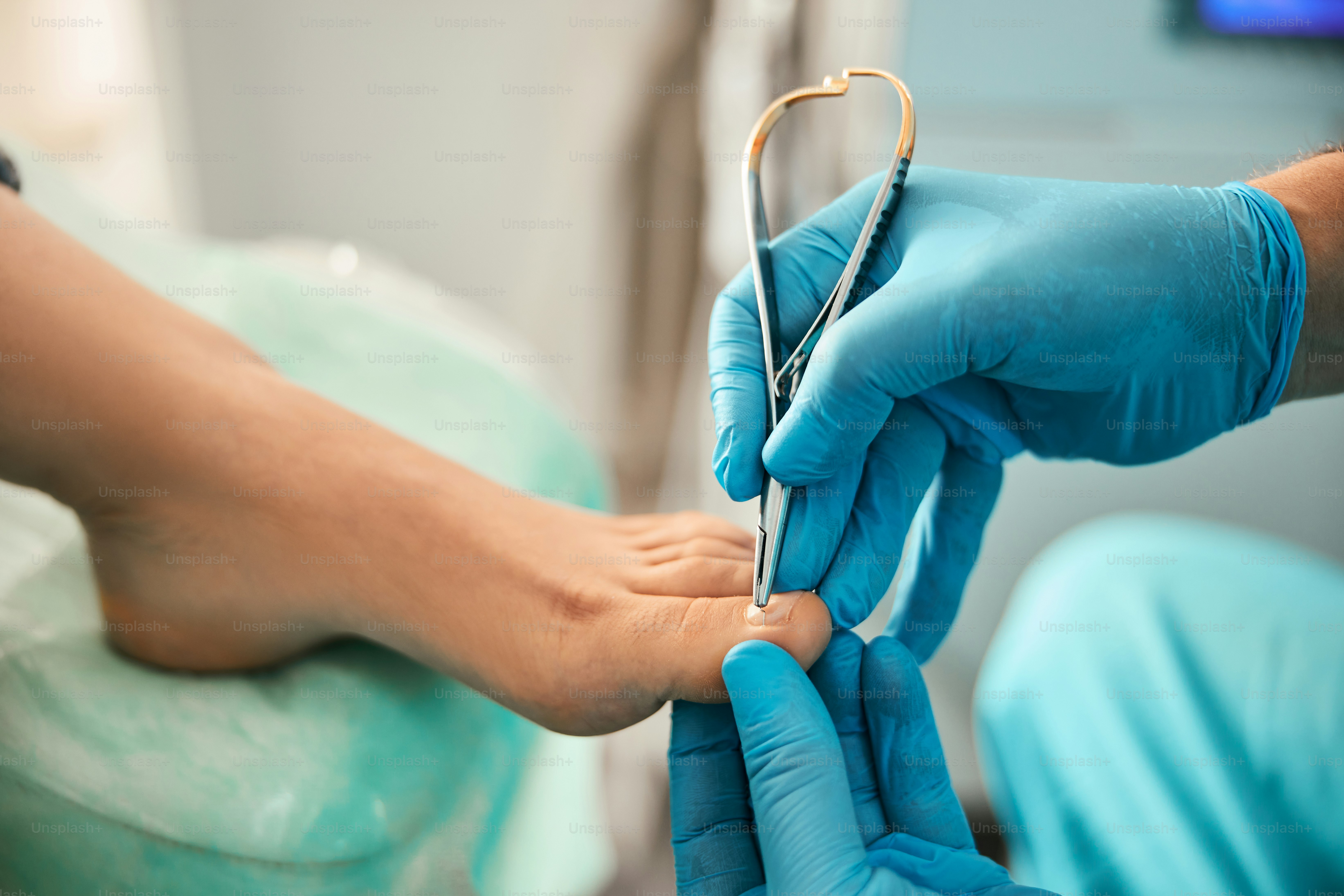 Close up portrait of female left leg on medical chair while doctor ...