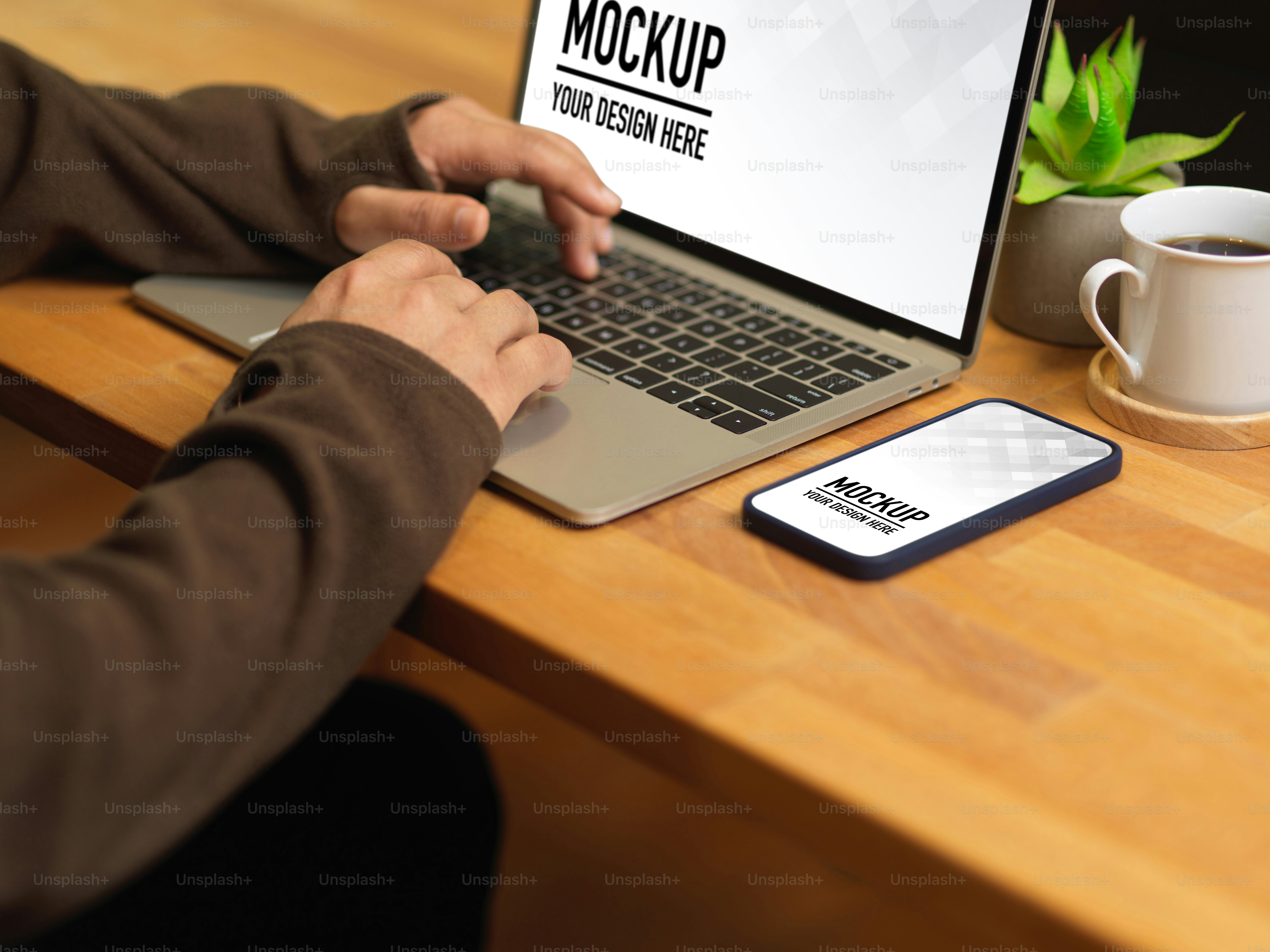 Side view of male hands typing on laptop keyboard on wooden table with ...