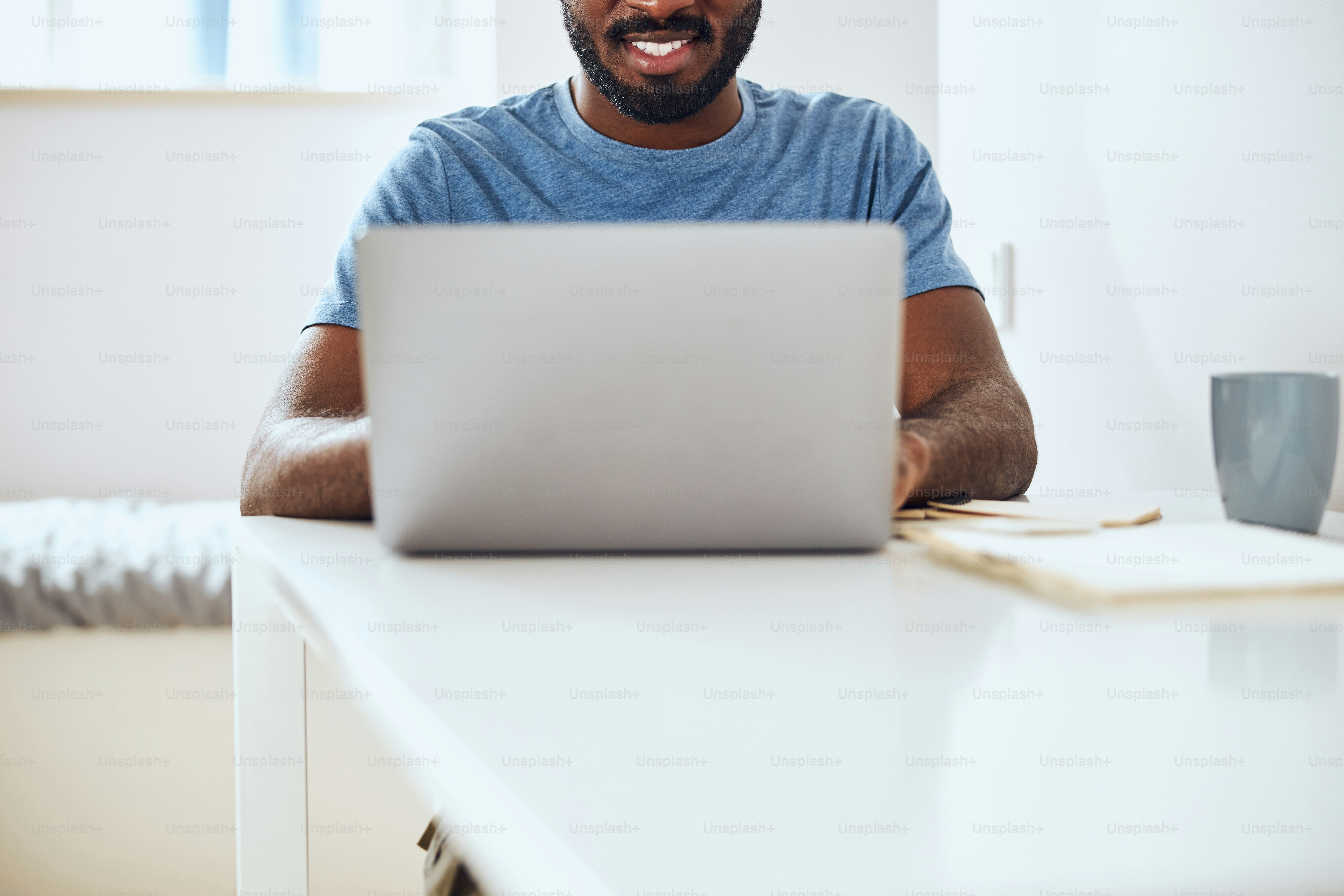 Cropped photo of a multiethnic citizen performing his job at home on his computer photo – Person ...