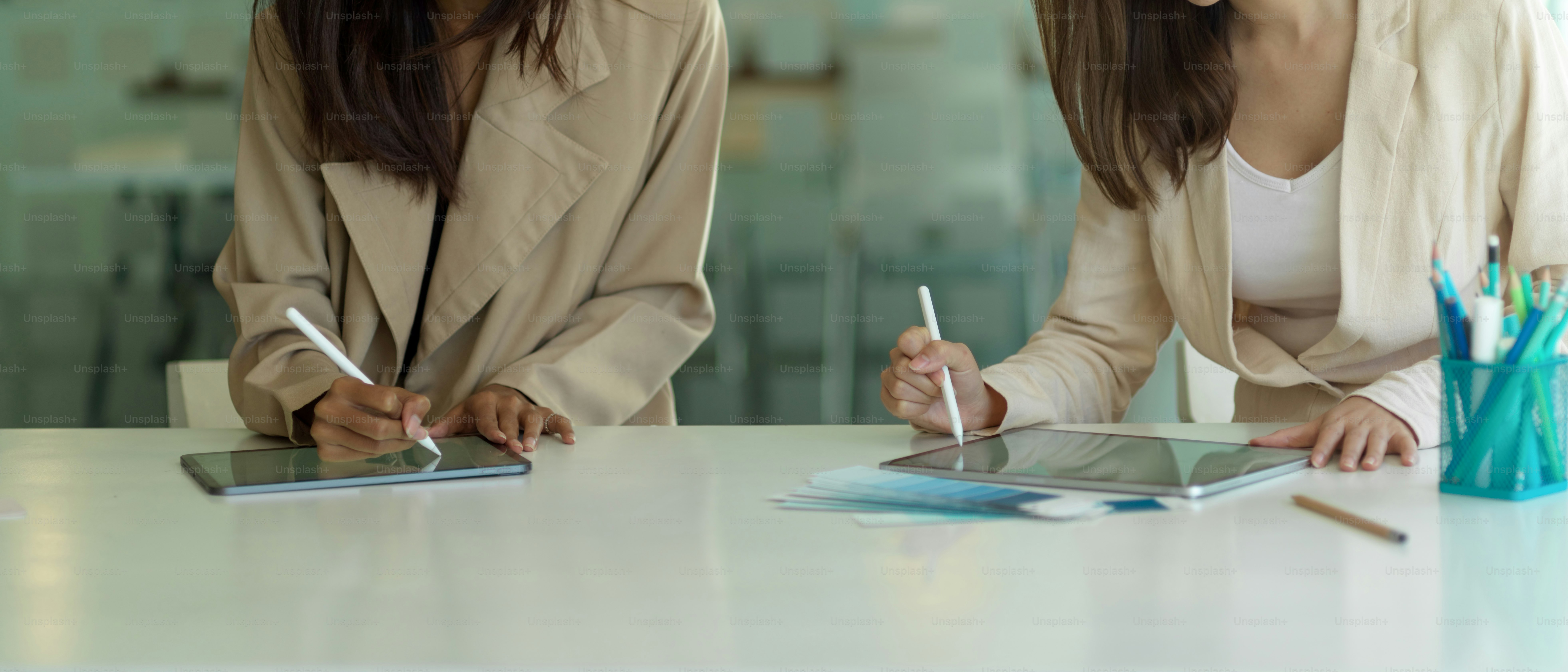 Cropped shot of businesswomen consulting on their project with tablet ...