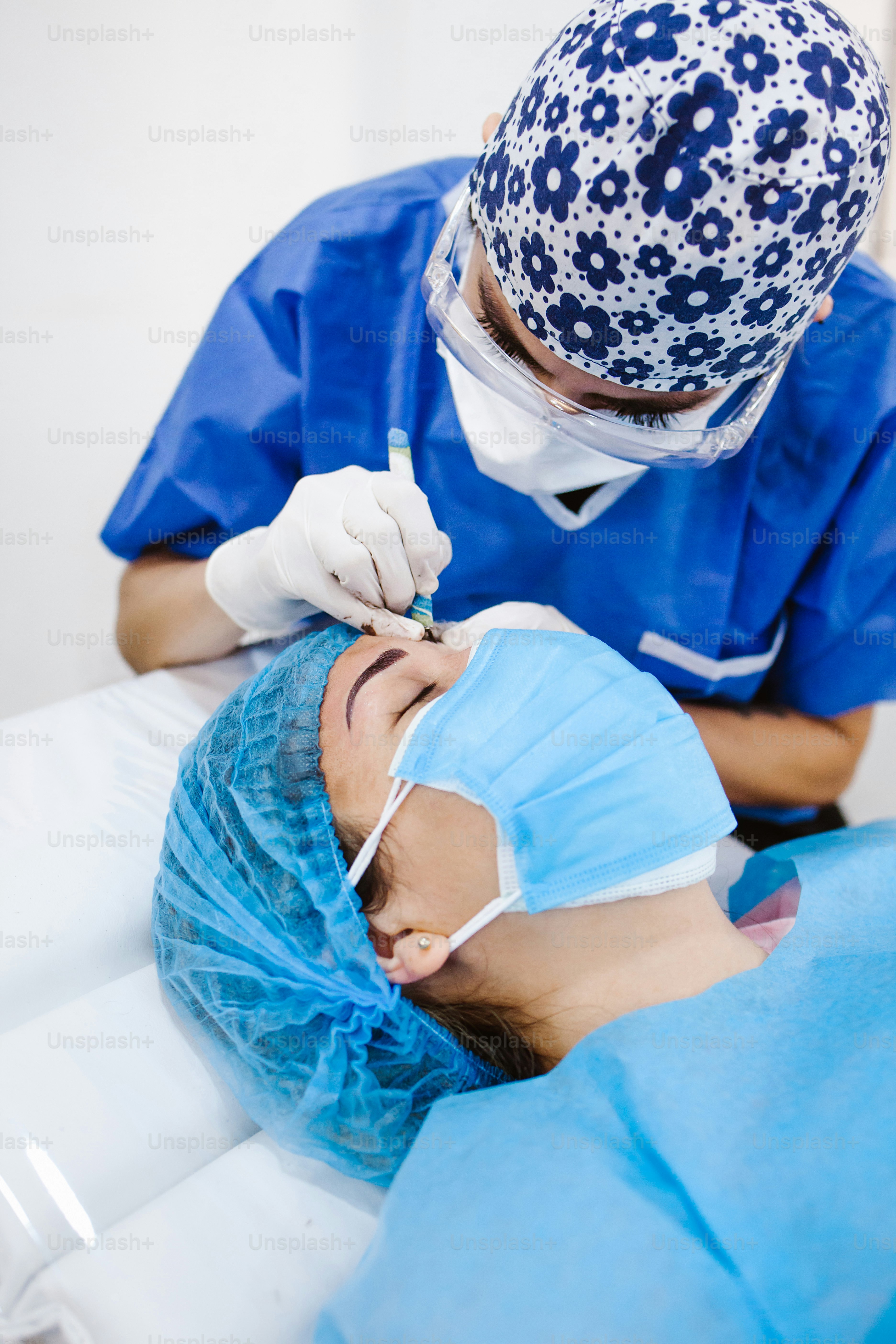 Latin woman Beautician Doing Eyebrow Tattooing For Female ...