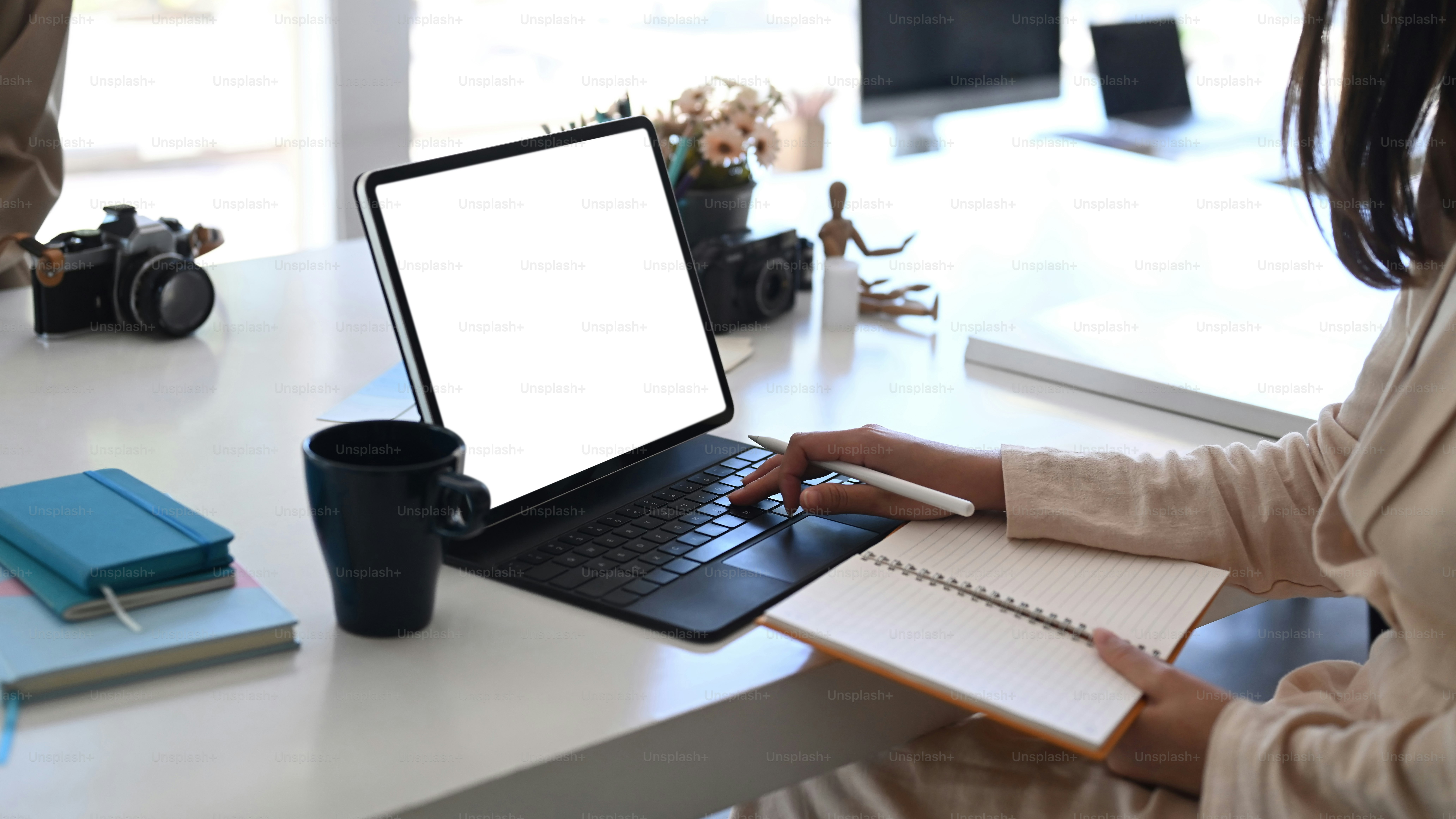 Young businesswoman working on her project with tablet computer and ...