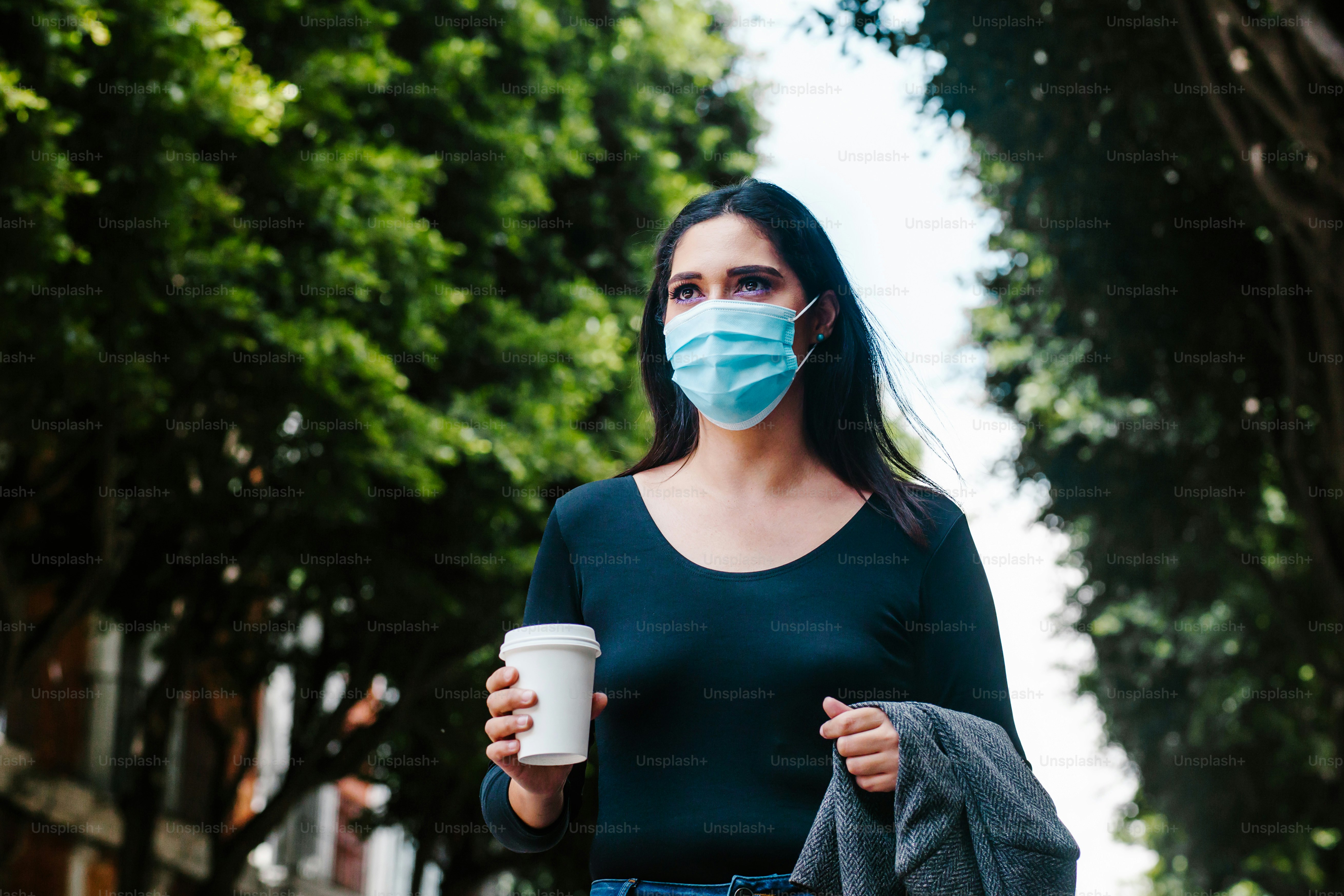 Portrait of Mexican business woman with face mask in the streets in a ...