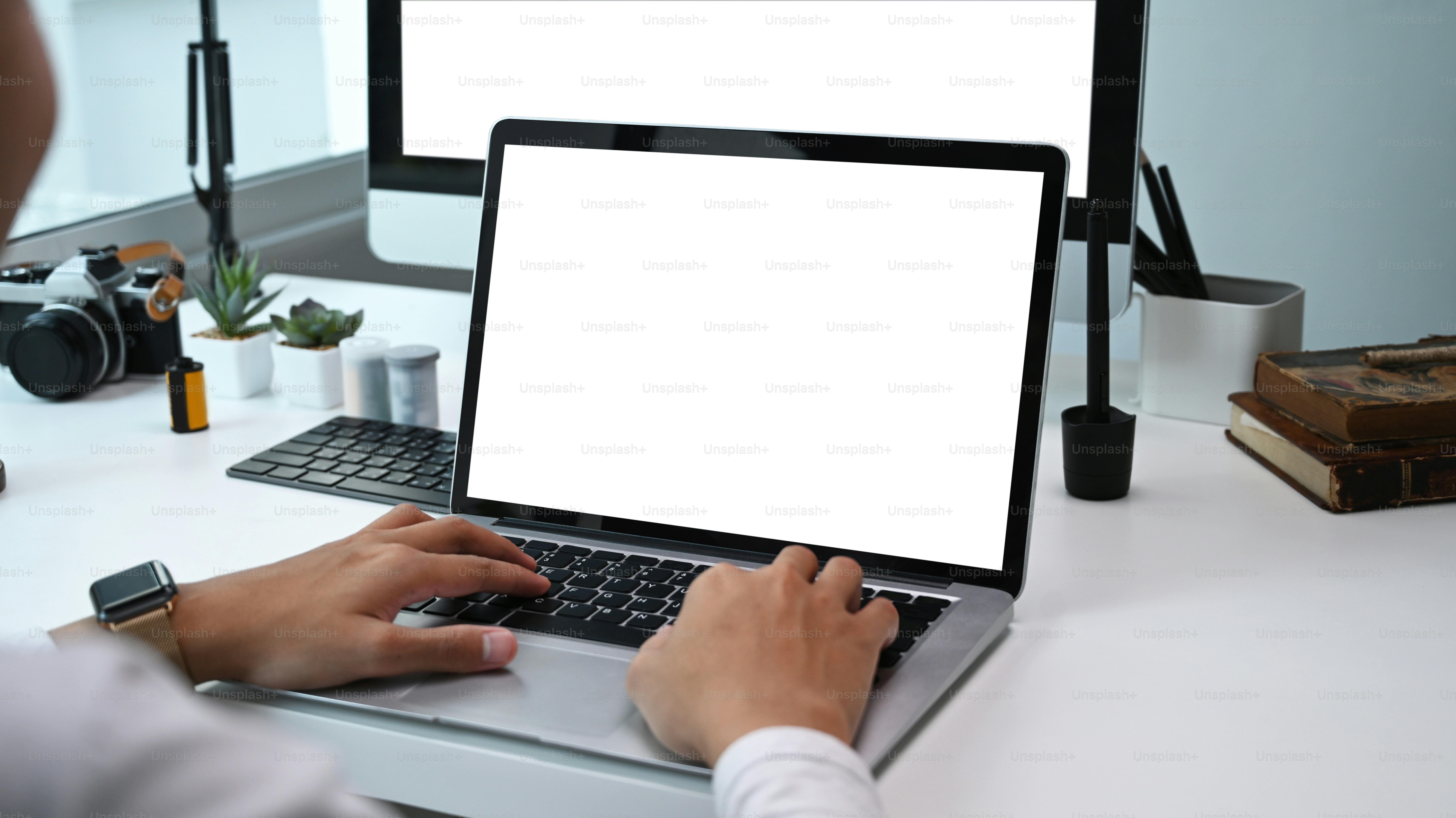 Rear view of photographer or graphic designer working with multiple ...