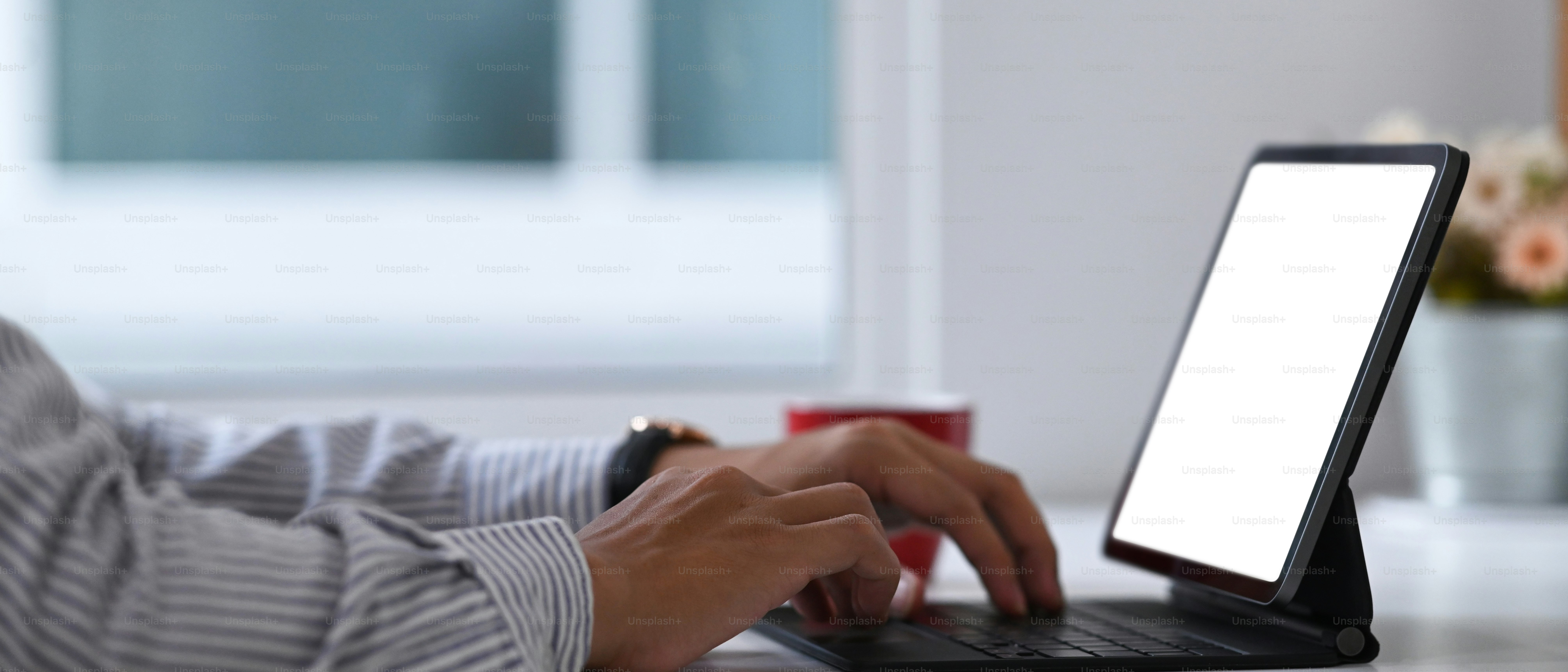 Horizontal photo of businessman hands typing on keyboard of tablet ...