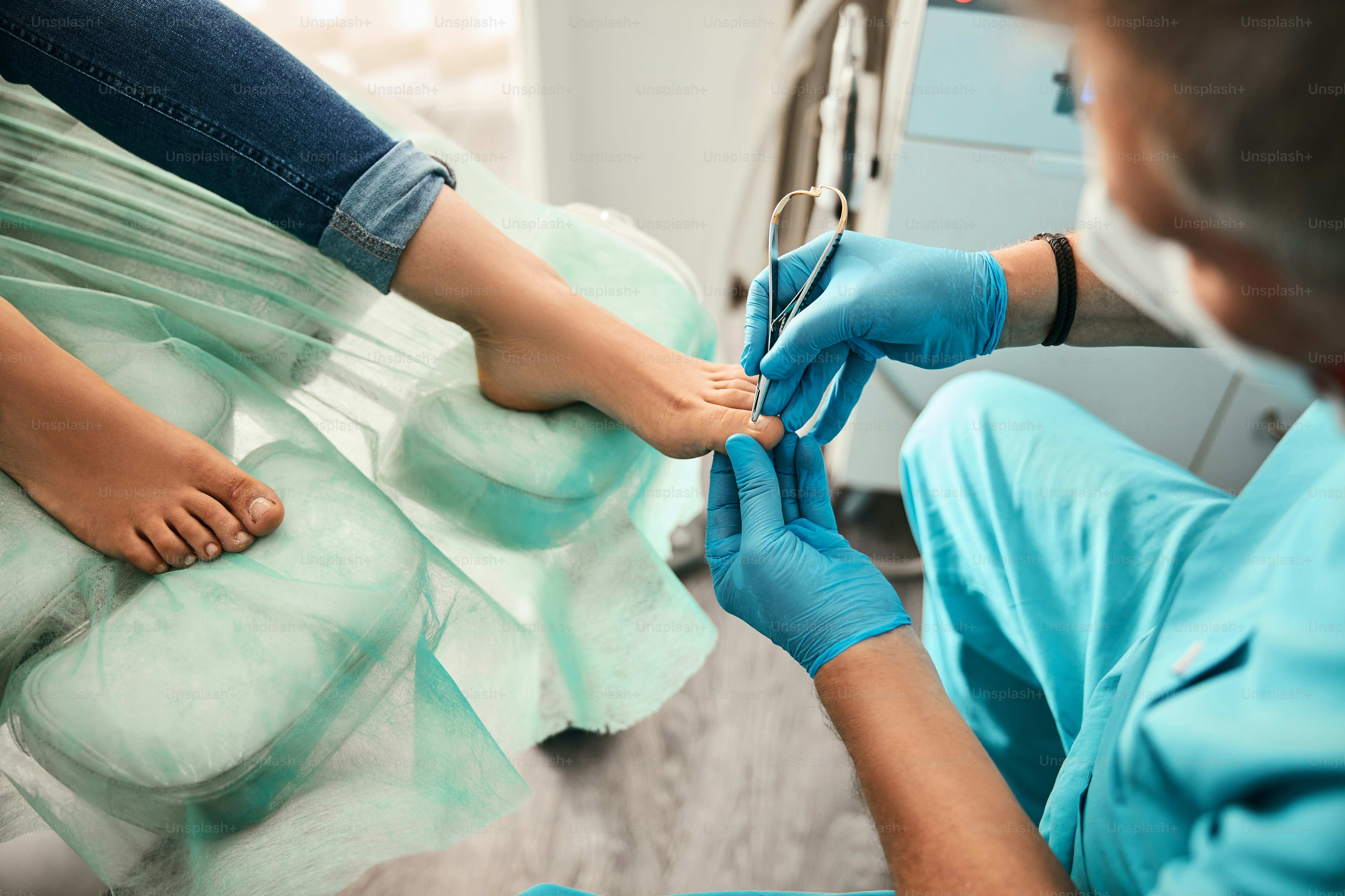 Side view portrait of female legs on the medical chair while doctor ...