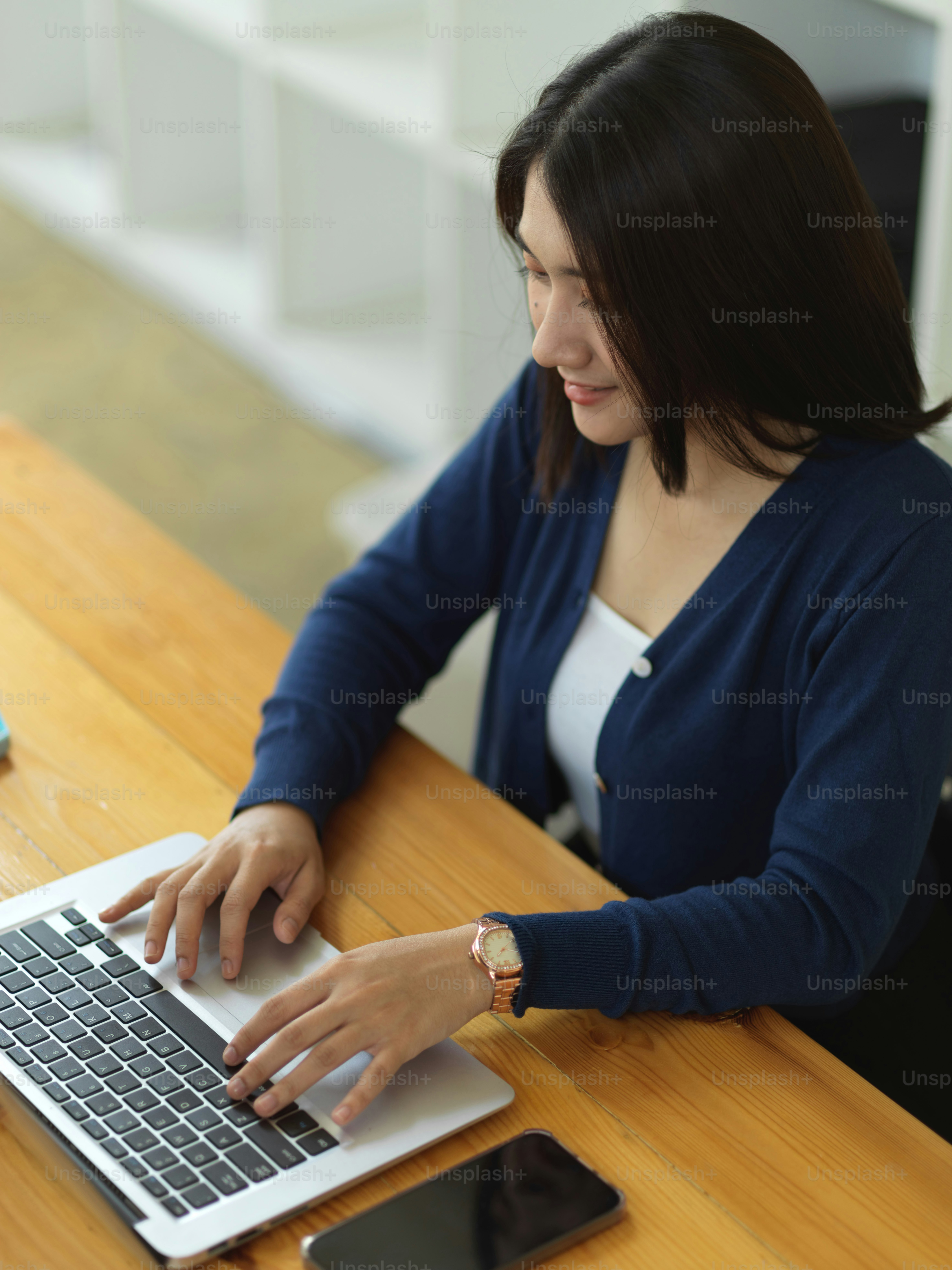 Top view of female university student doing assignment with laptop in ...