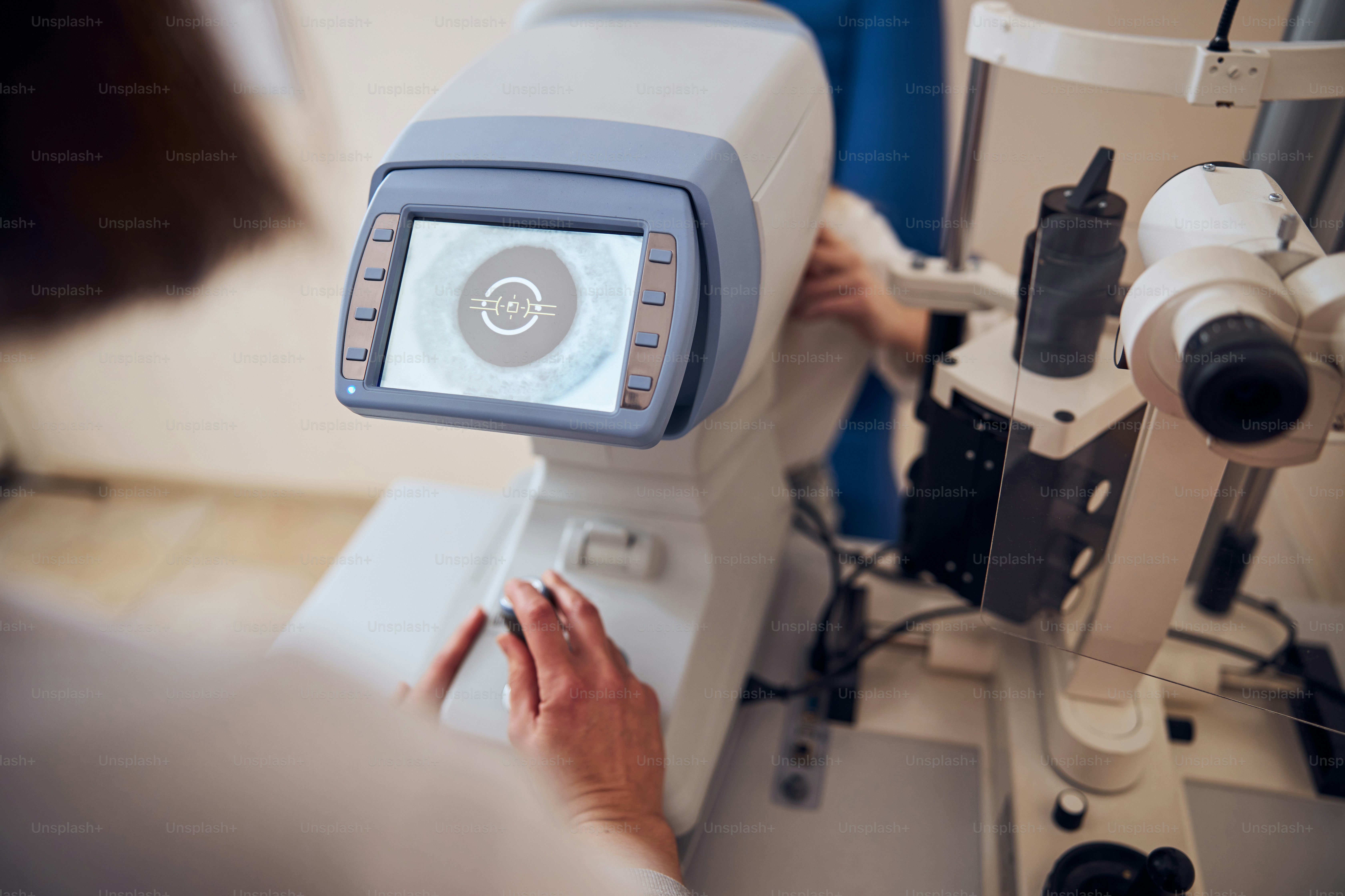 Focused image of doctor hand managing slit lamp in office of pediatric ...