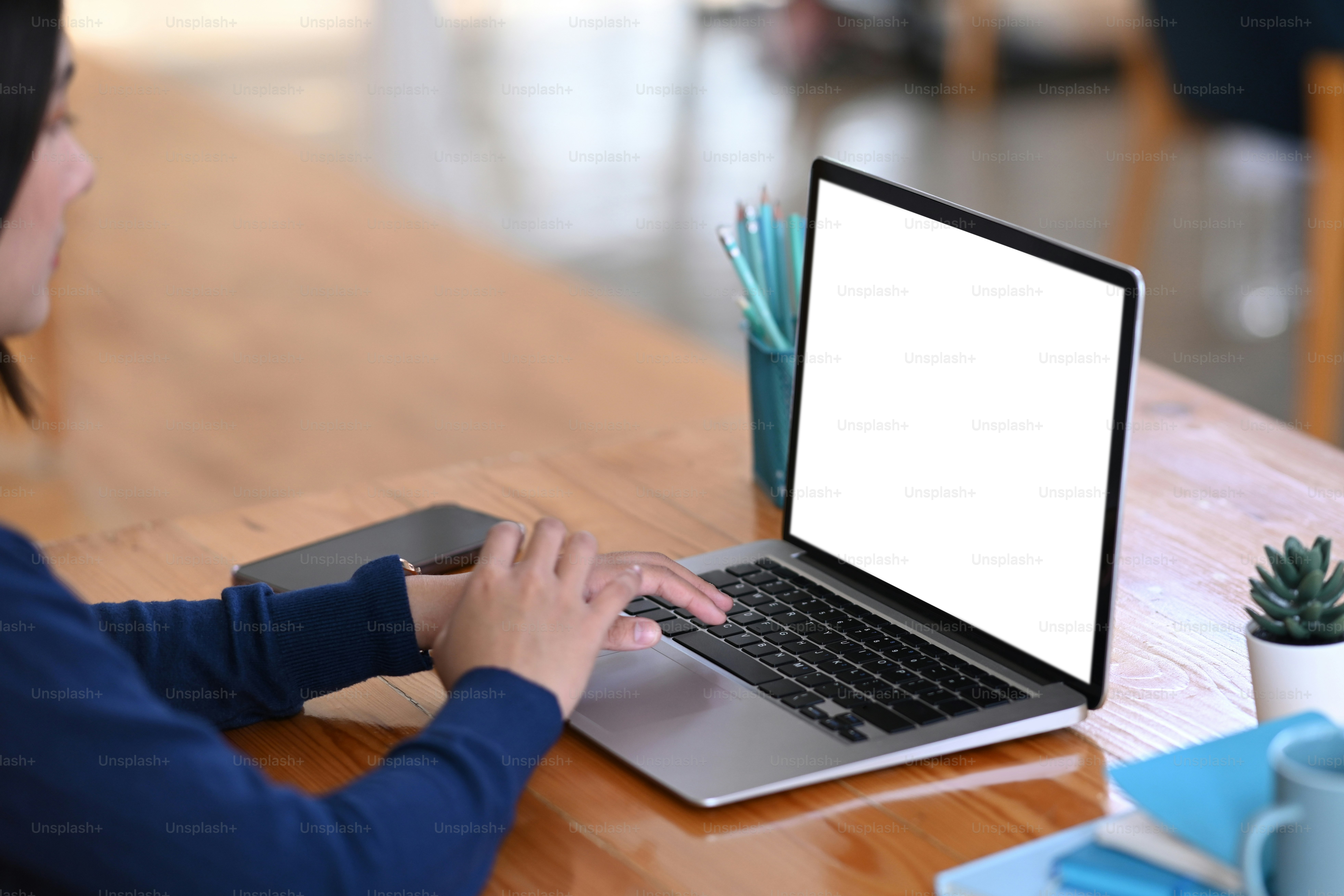 Side view of female freelance working with laptop computer at her ...