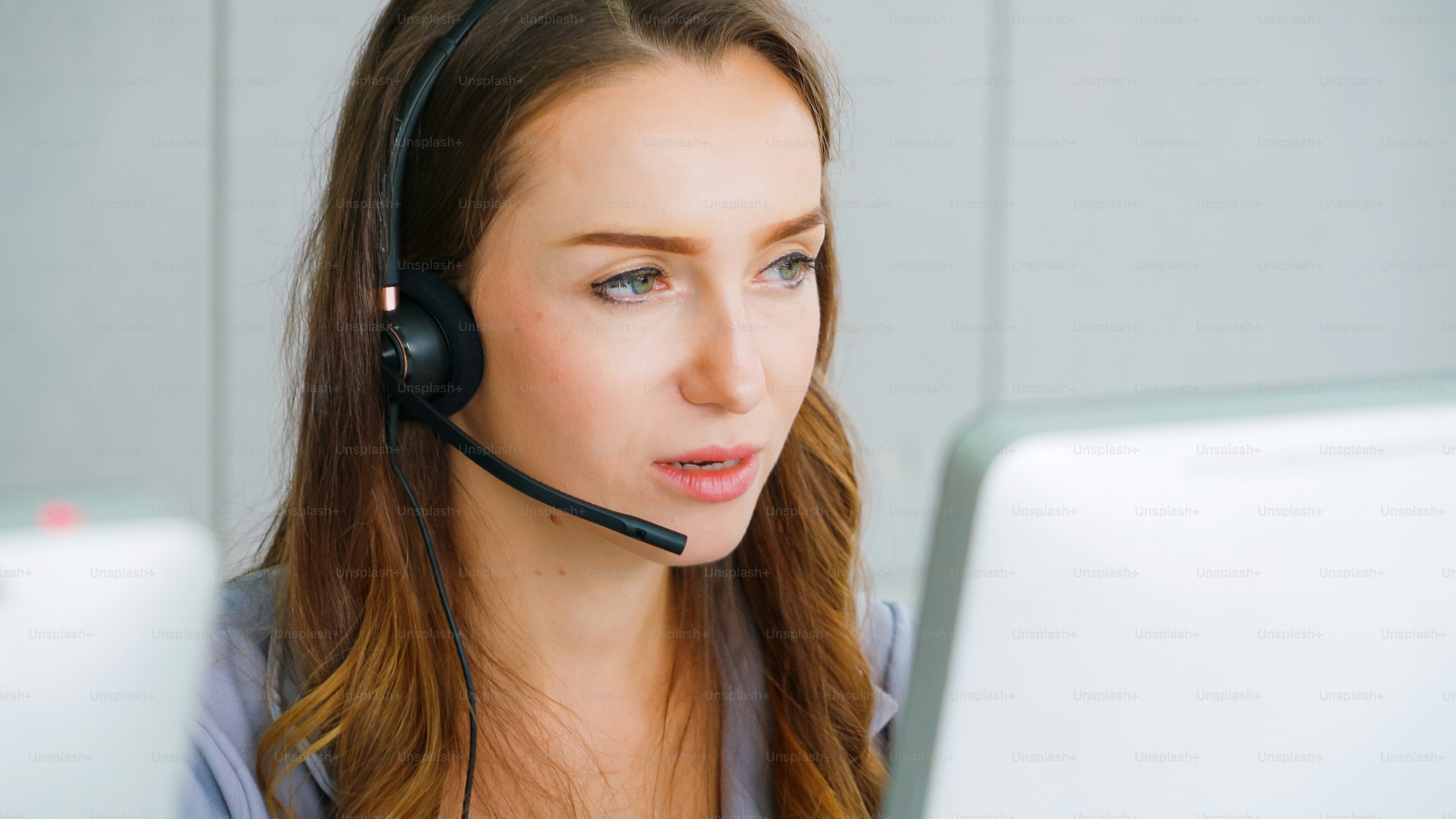 Business people wearing headset working in office to support remote ...