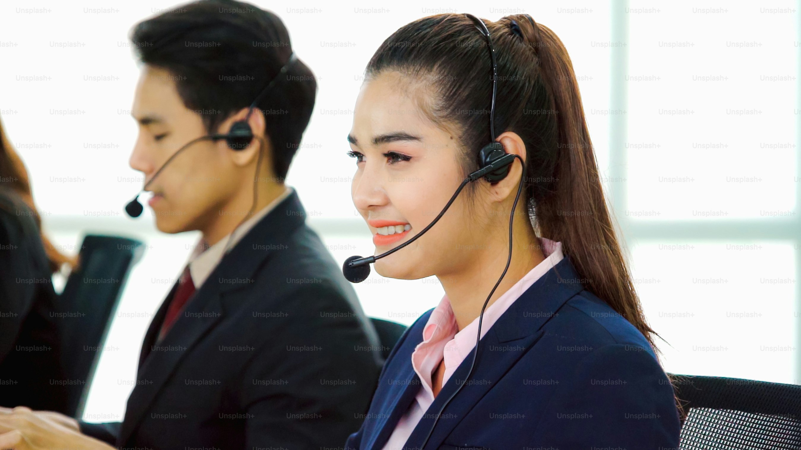 Business people wearing headset working in office to support remote ...