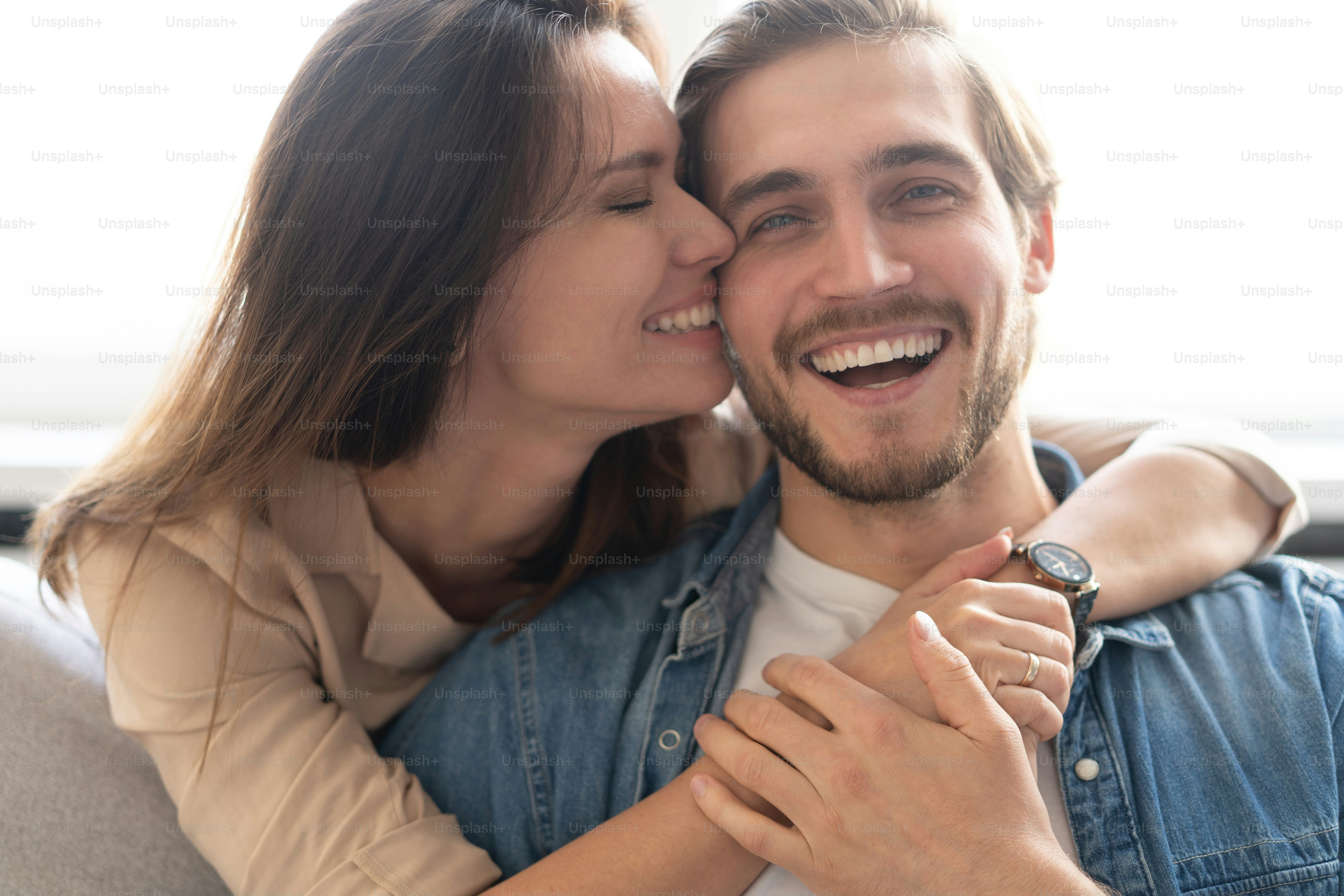 Happy couple or marriage hugging and enjoying in a couch at home photo ...